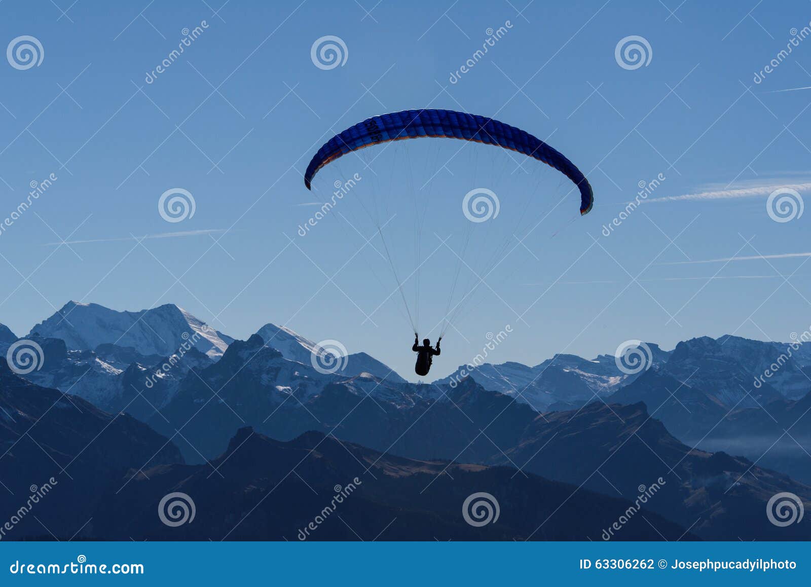 Paragliding over mountains stock photo. Image of flight - 63306262