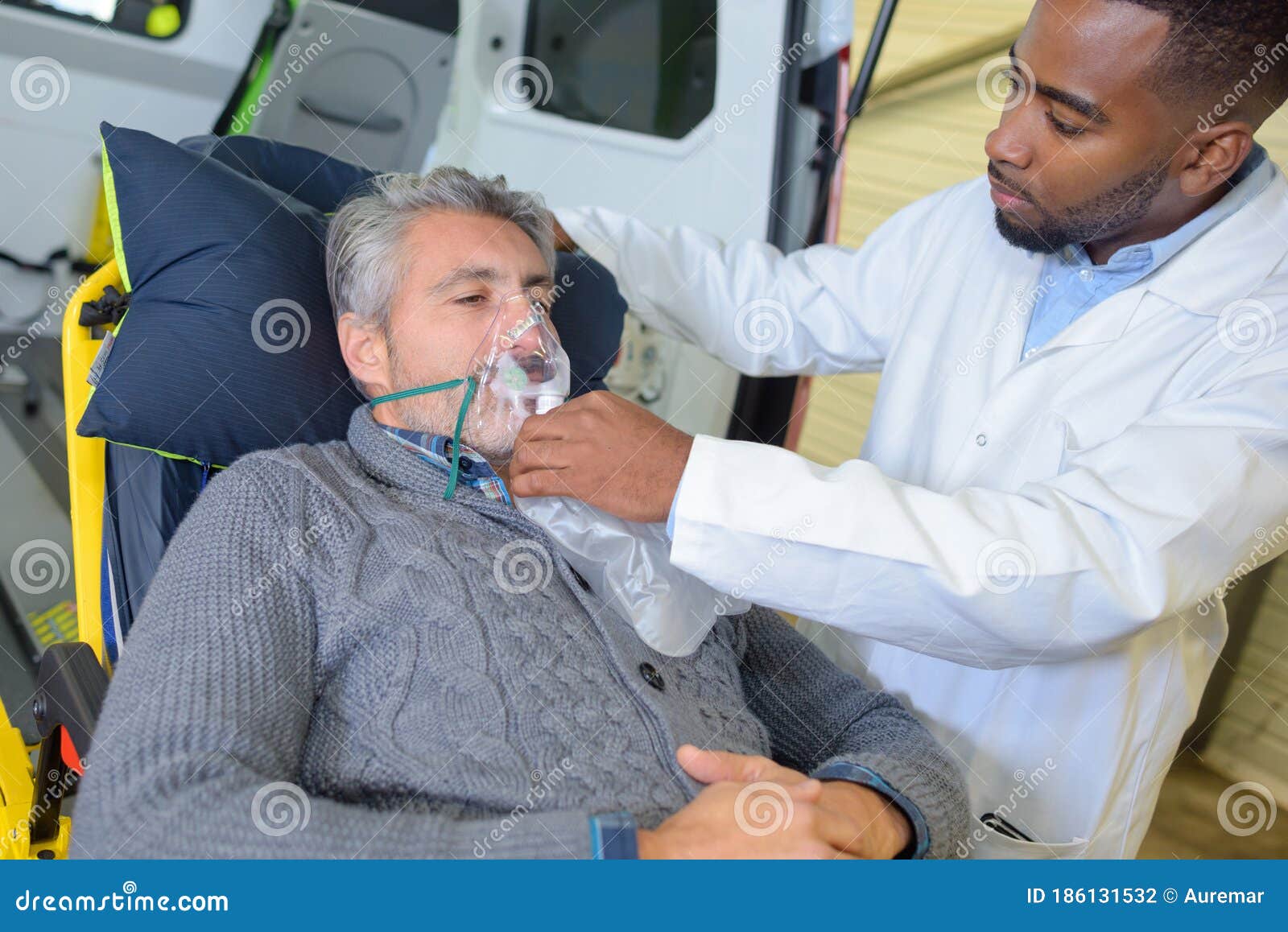 Paramedic Giving Oxygen To Patient Stock Photo - Image of lying ... Paramedic Giving Oxygen To Patient Stock Photo - Image of lying ...