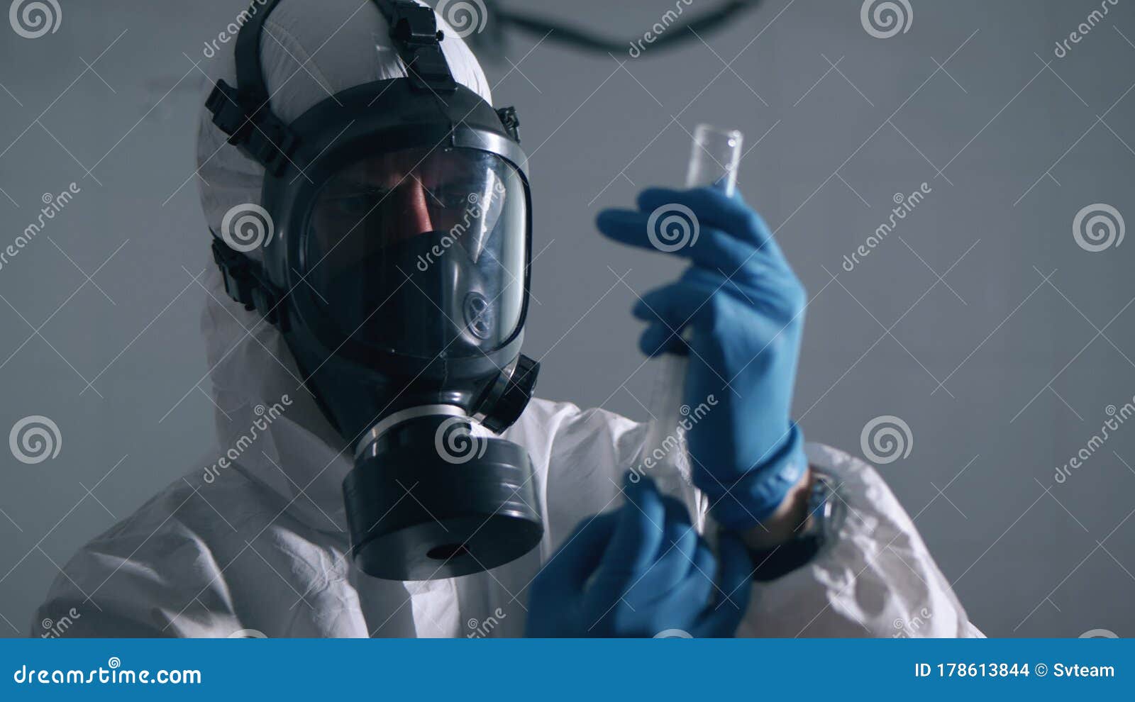 Paramedic in a Hazmat Suit is Preparing a Syringe for an Injection ...