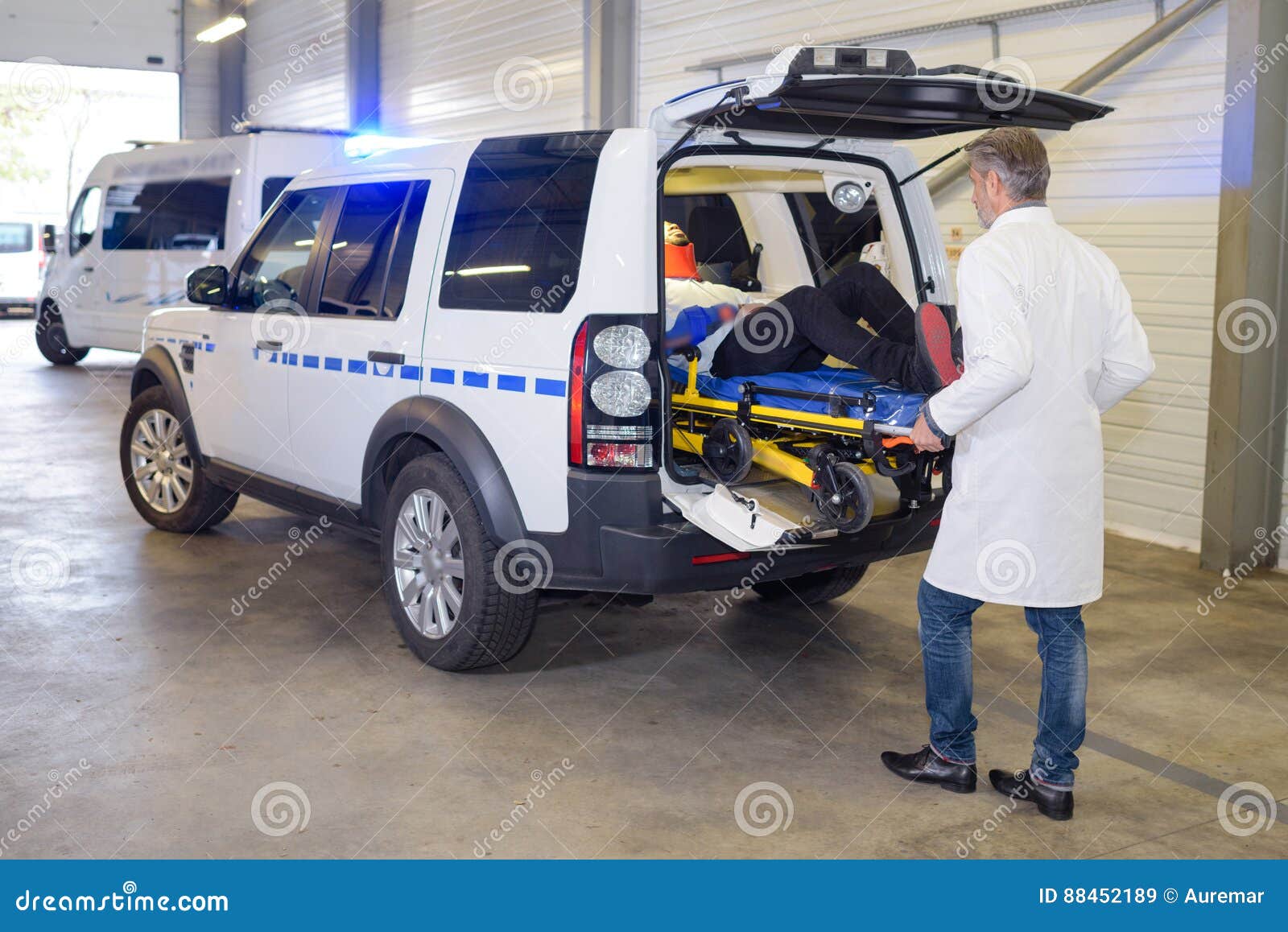 Paramedic Loading Stretcher into Back Ambulance Stock Image - Image of ...