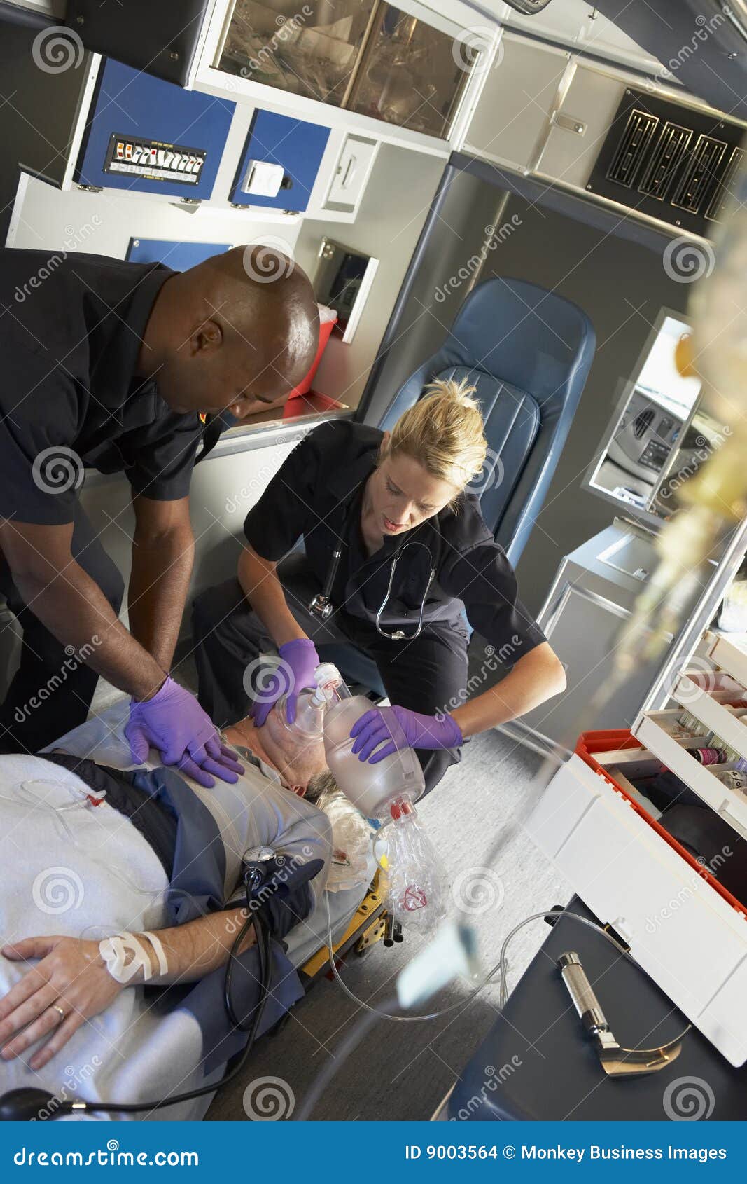 Paramedic with Patient in Ambulance Stock Photo - Image of gurney ...