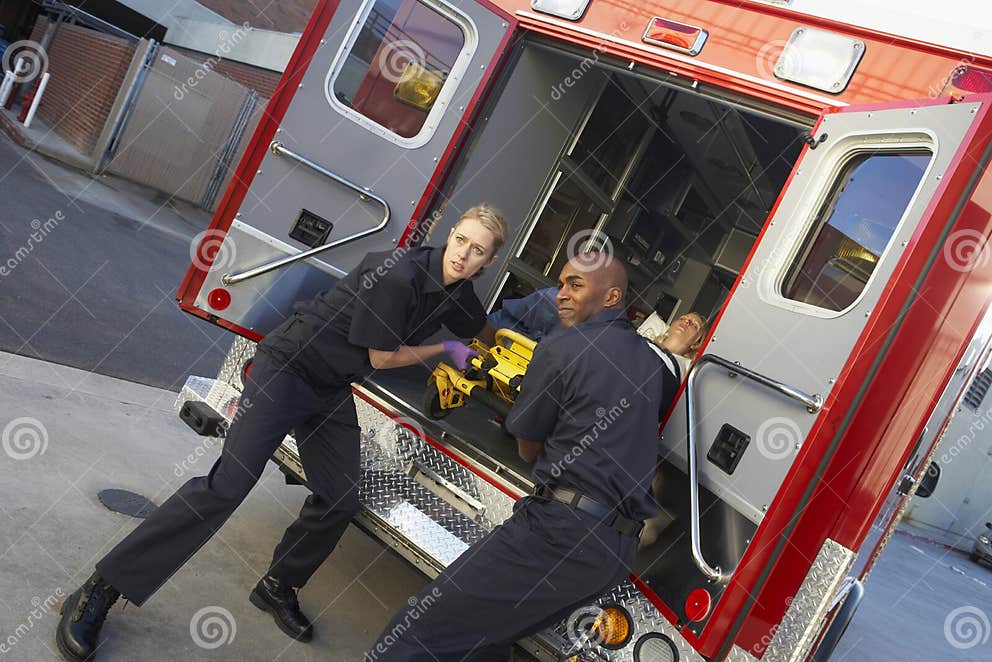 Paramedic Preparing To Unload Patient Stock Photo - Image of doctor ...