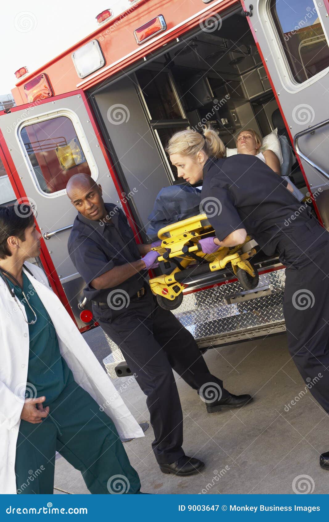 Paramedic Preparing To Unload Patient Stock Image - Image of gurney ...