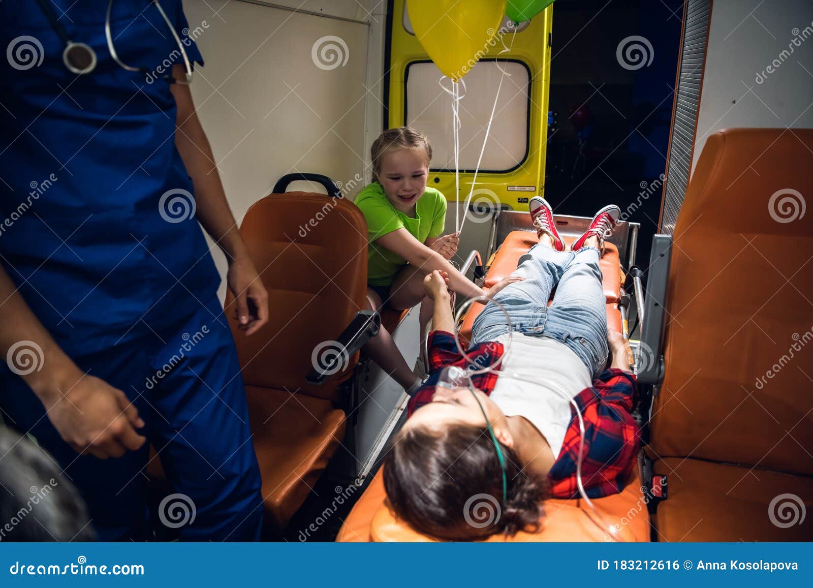 A Paramedic Stands Over The Unconscious Woman Lying On A Stretcher In