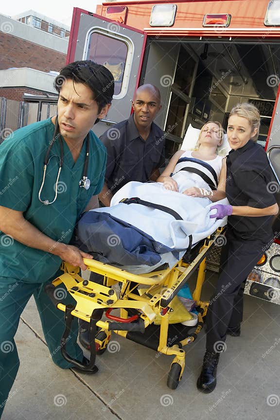 Paramedics and Doctor Unloading Patient Stock Photo - Image of people ...