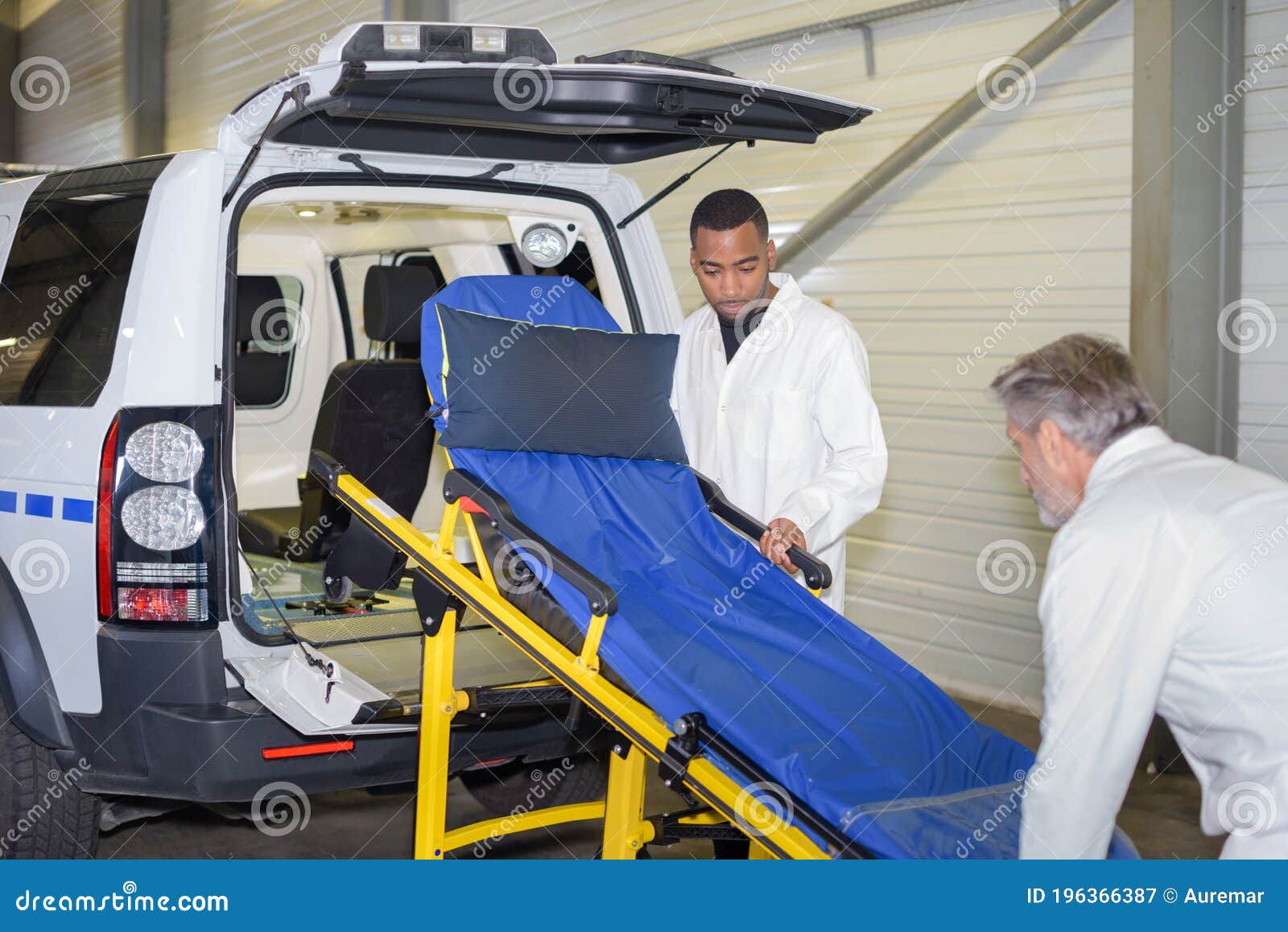 Paramedics Loading Stretcher into Emergency Vehicle Stock Image - Image ...