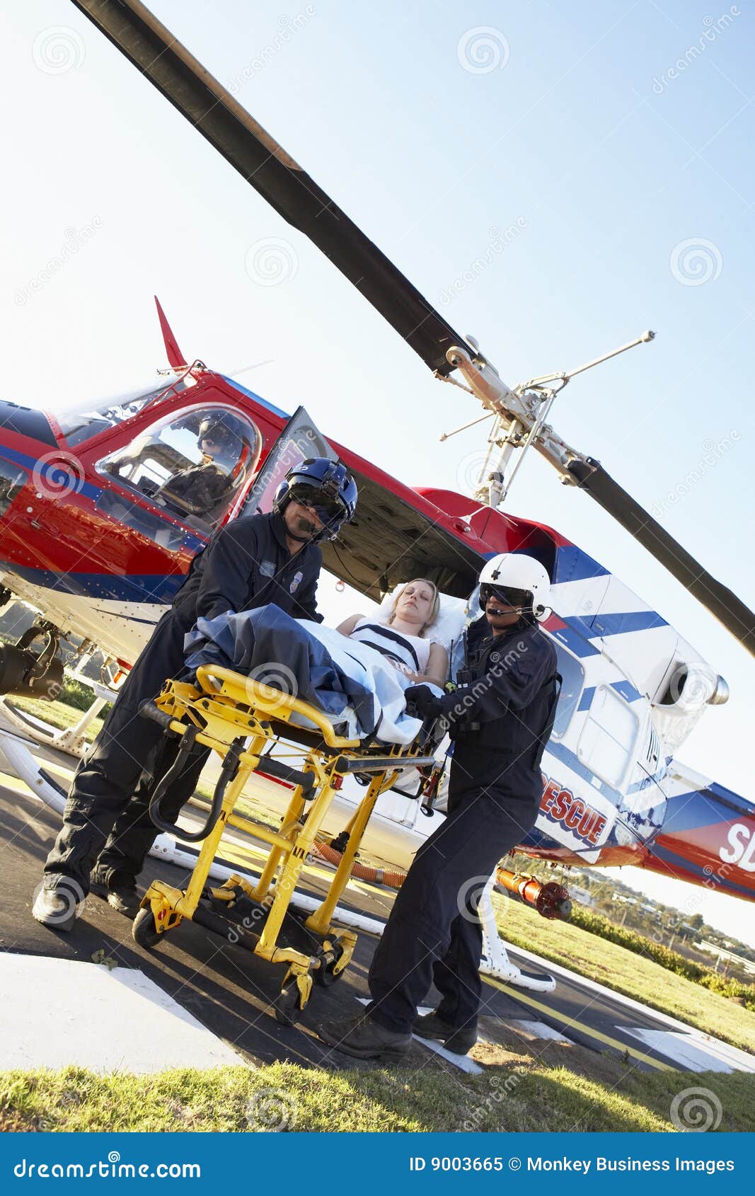 Paramedics Unloading Patient from Helicopter Stock Image - Image of ...