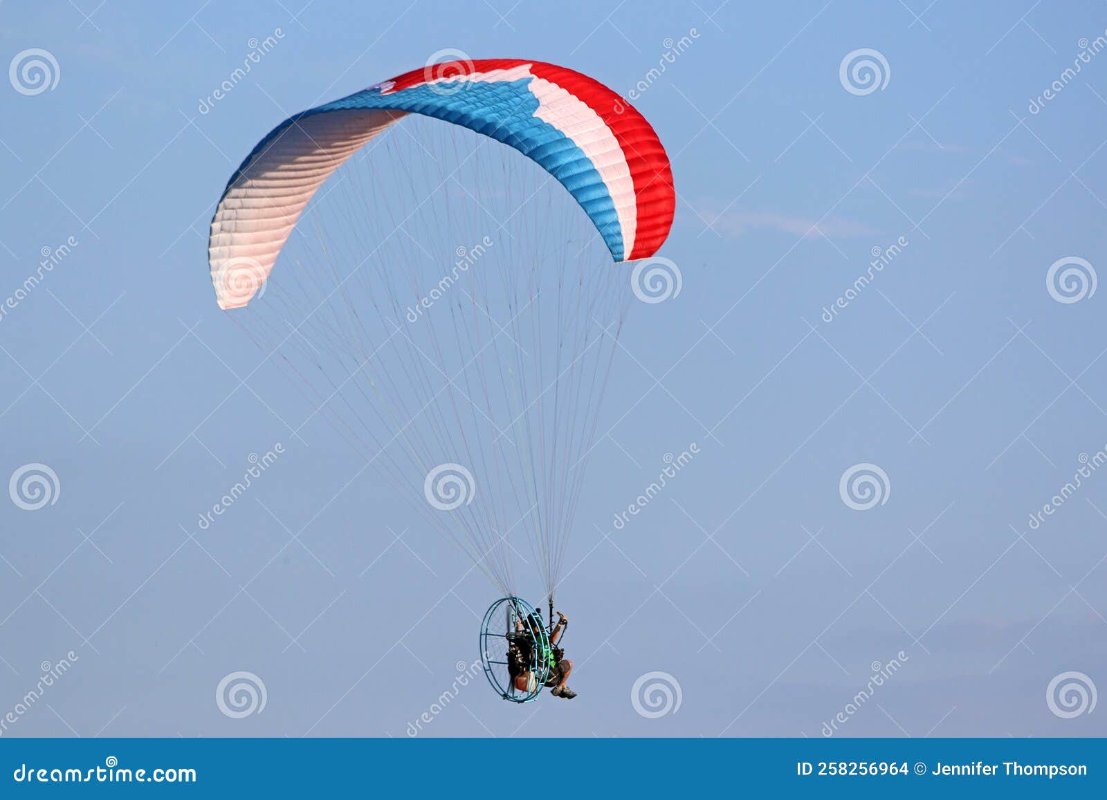 Paramotor Pilot Flying in a Blue Sky Stock Photo - Image of paraglider ...