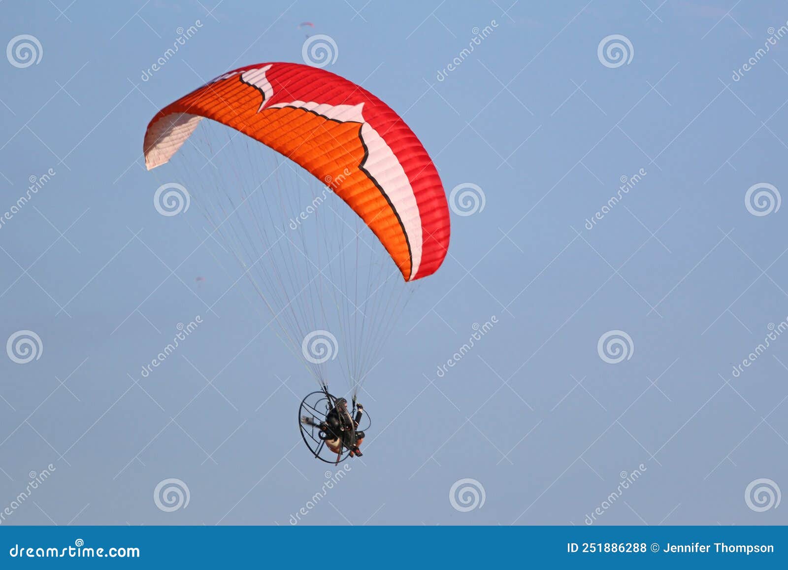 Paramotor Pilot Flying in a Blue Sky Stock Photo - Image of paramotor ...