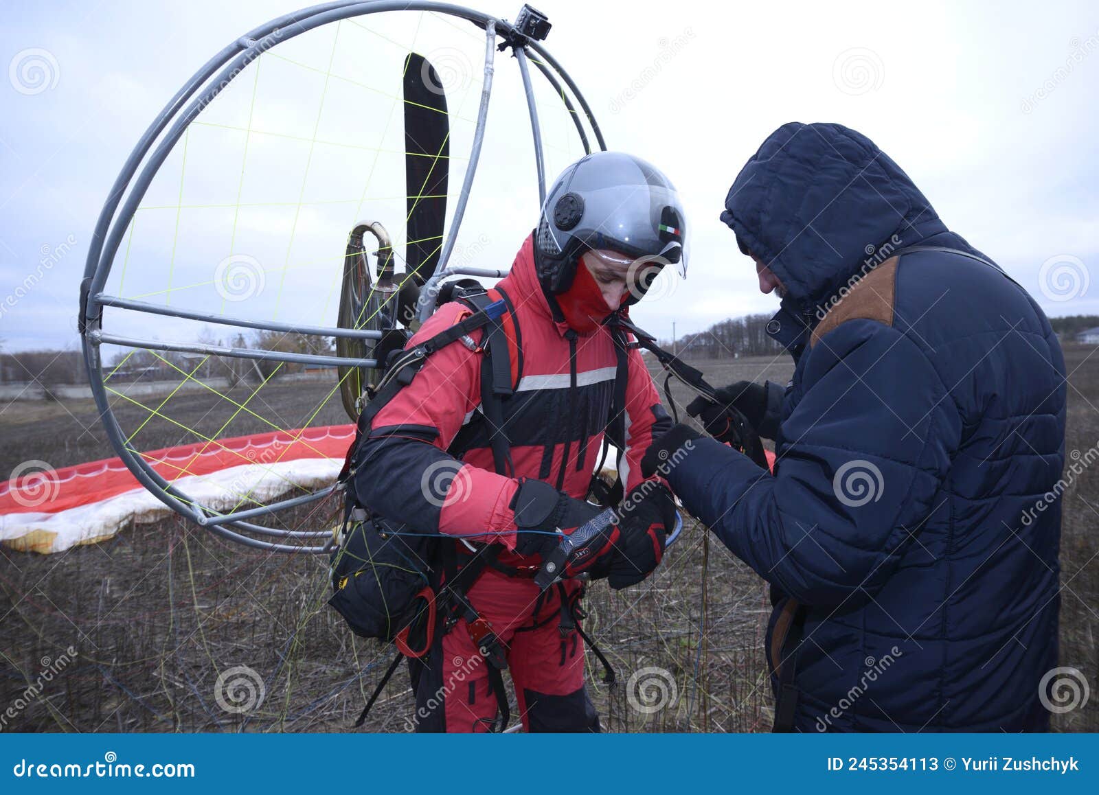 Paramotoring. Instructor Helping the Paramotorist To Prepare Equipment ...