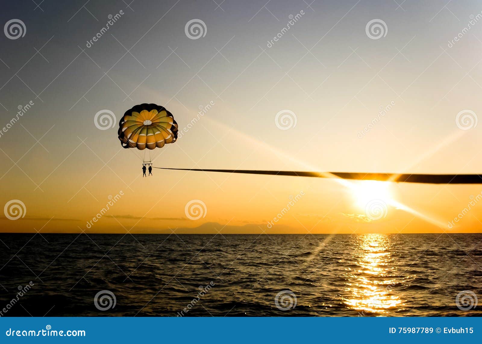 Parasailing during sunset. stock image. Image of water - 75987789