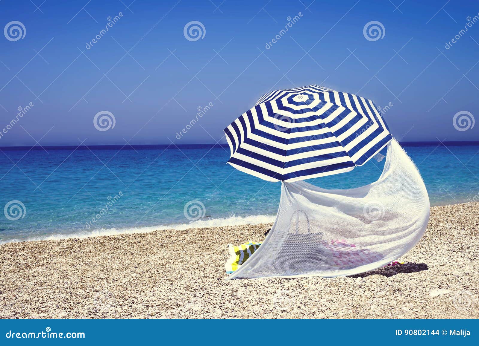Parasol on sandy beach stock photo. Image of scenery - 90802144