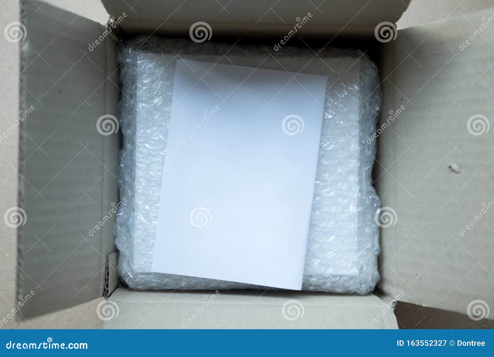 Parcel in Brown Box with Bubble Wrap for Protection Parcel Product ...