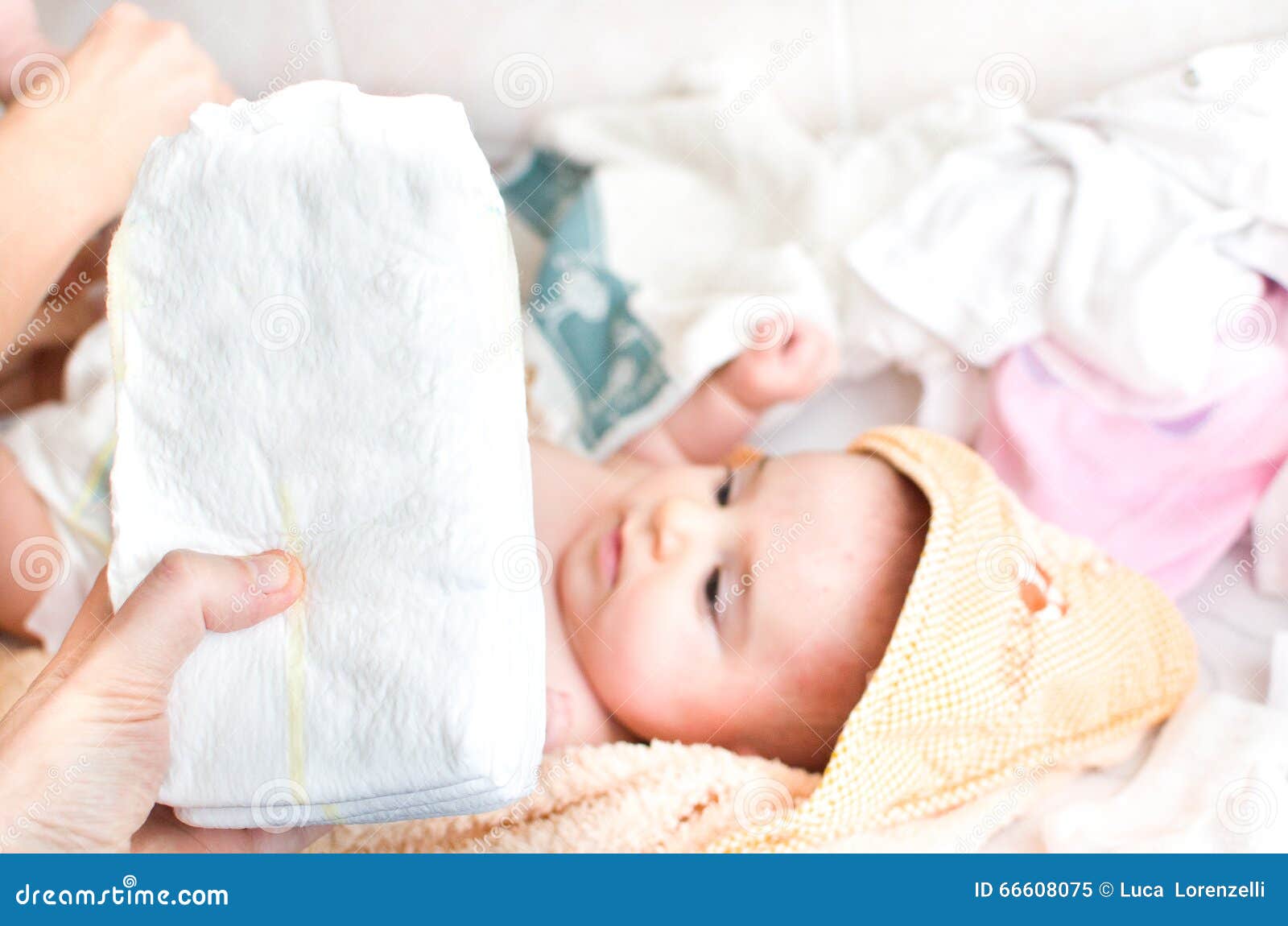 Parental Hand Holds Stack of Diapers Baby on Changing Table Stock Image ...