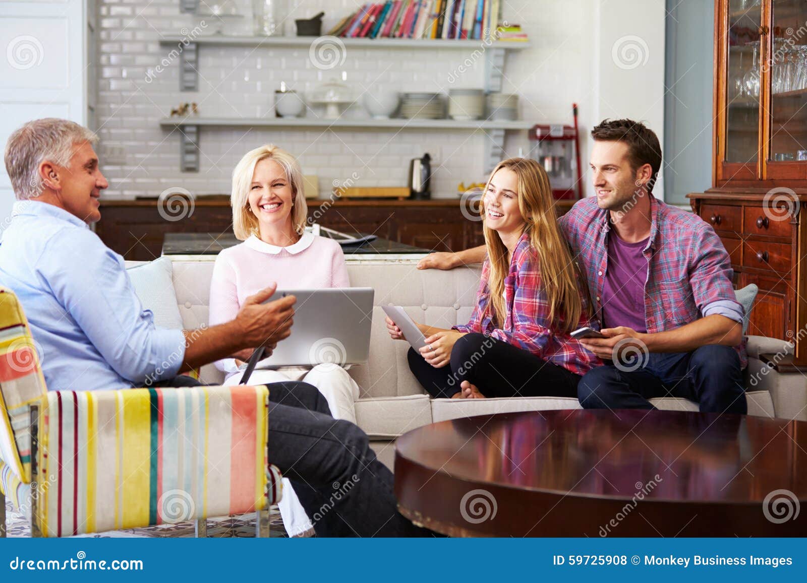 Parents with Adult Offspring Using Digital Devices at Home Stock Photo ...
