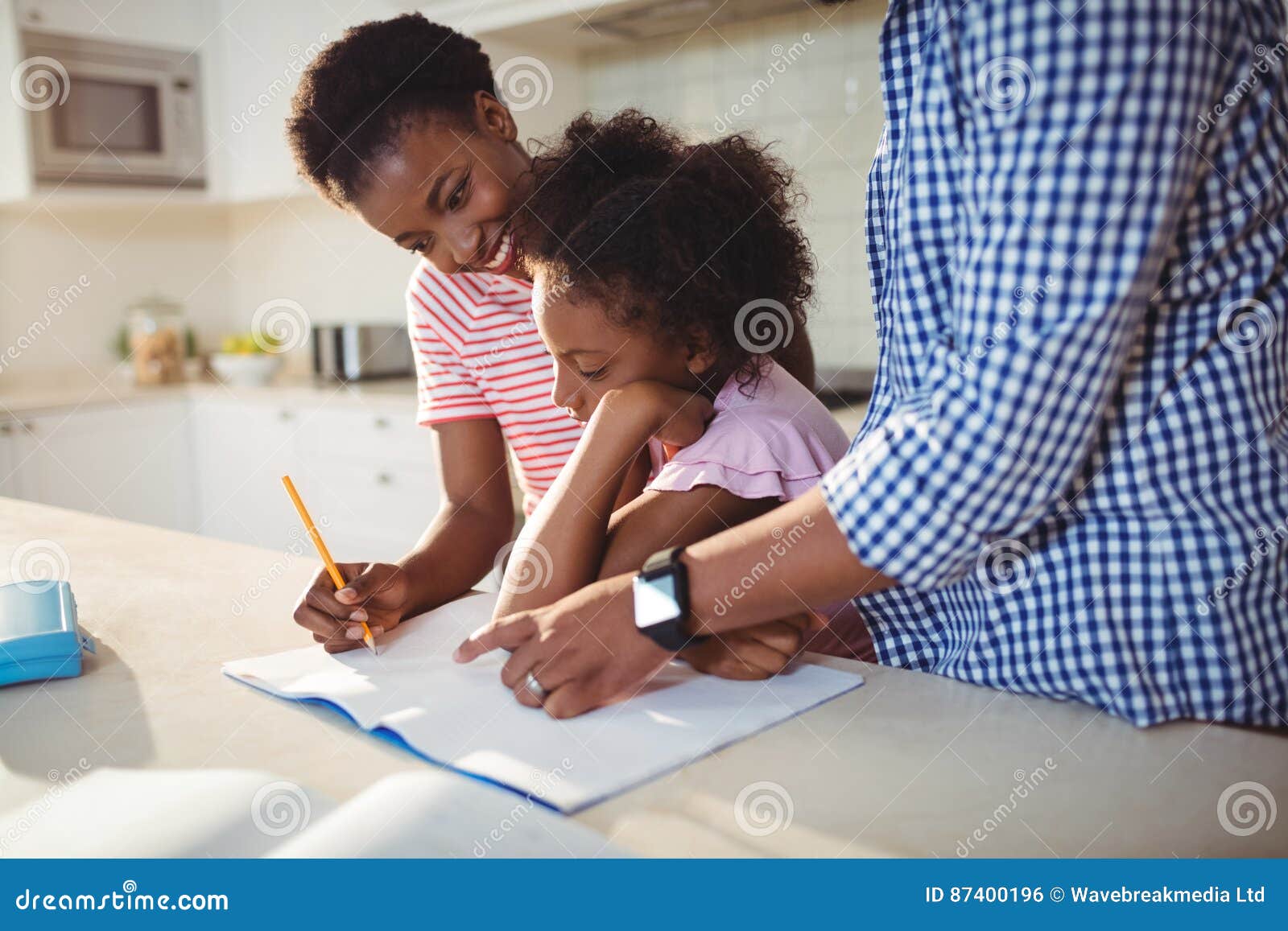 Parents Assisting Daughter with Homework Stock Photo - Image of ...