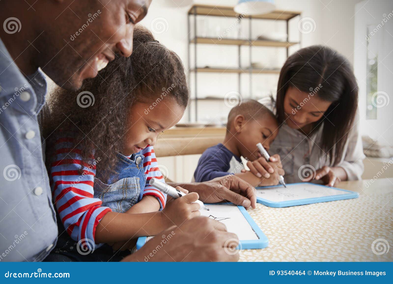 Parents and Children Drawing on Whiteboards at Table Stock Photo ...