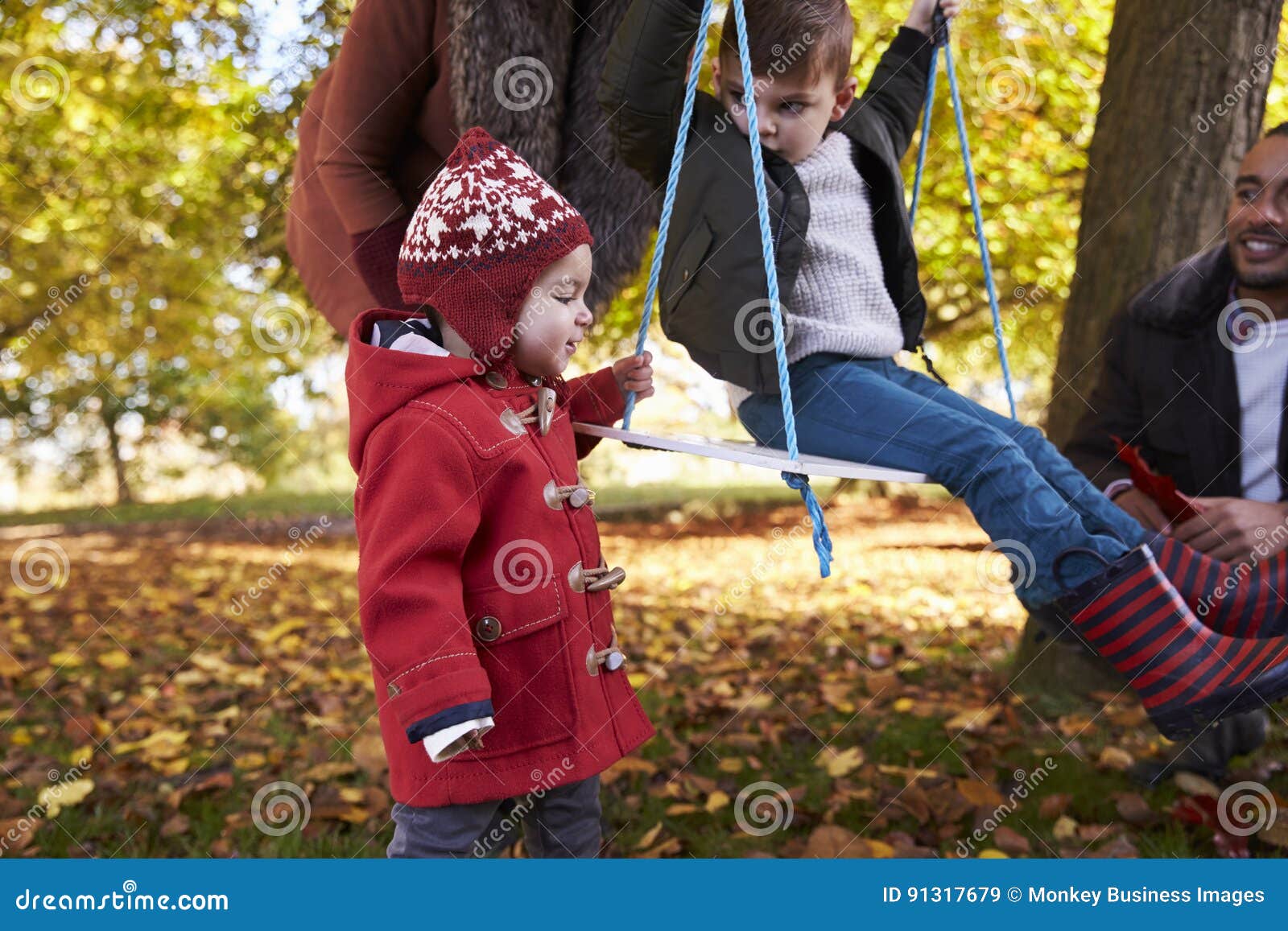 Parents with Children Playing on Tree Swing in Autumn Garden Stock ...