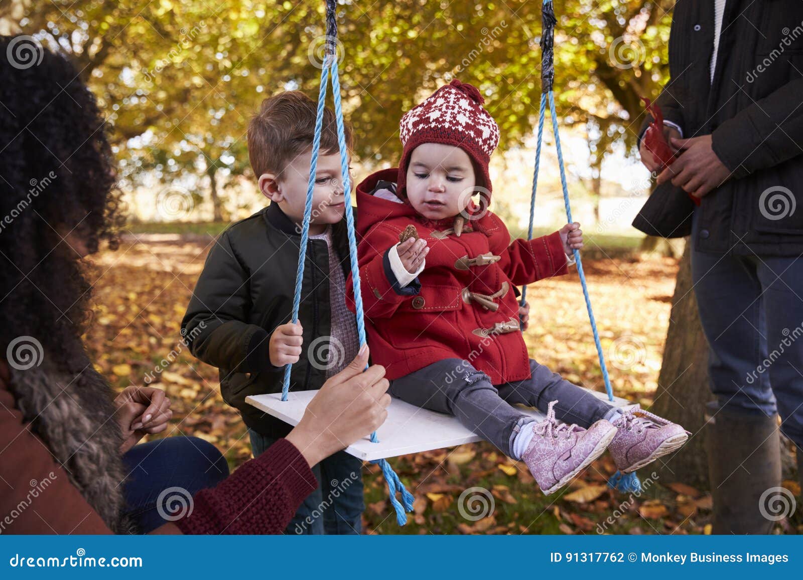 Parents with Children Playing on Tree Swing in Autumn Garden Stock ...