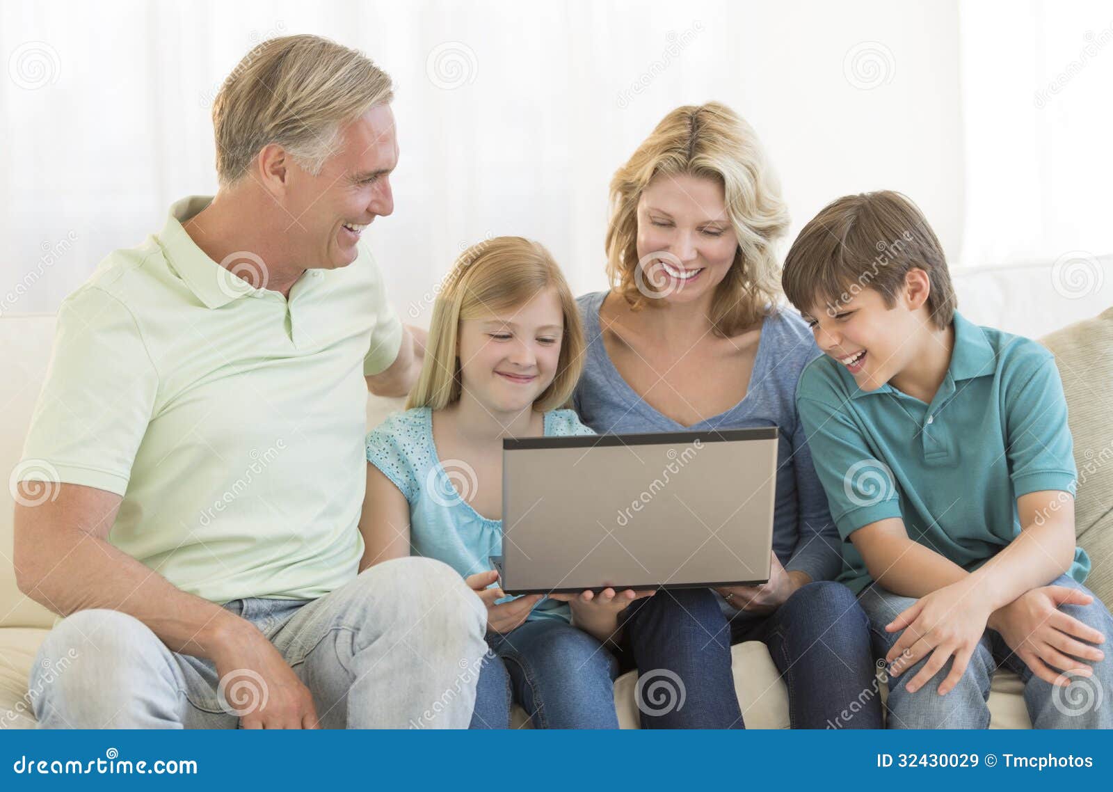 Parents and Children Using Laptop Together on Sofa Stock Image - Image ...