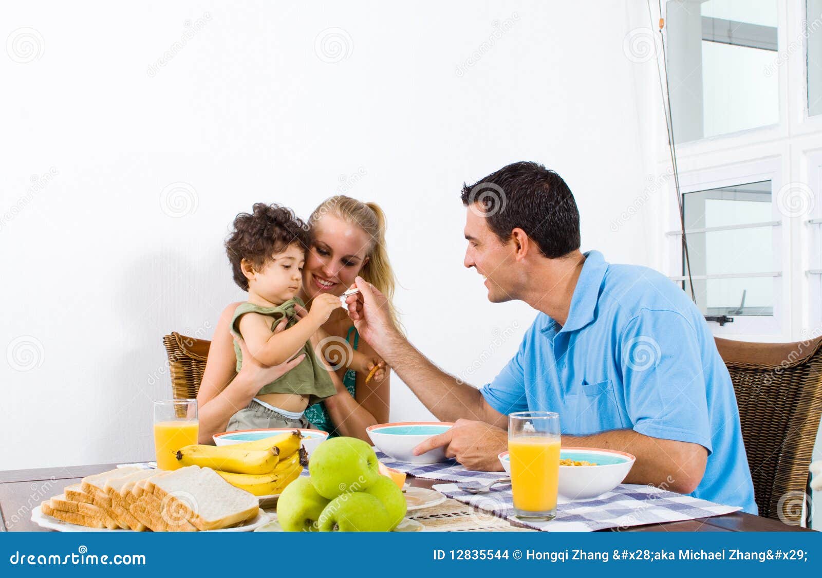 Parents feeding baby stock photo. Image of caring, couple - 12835544