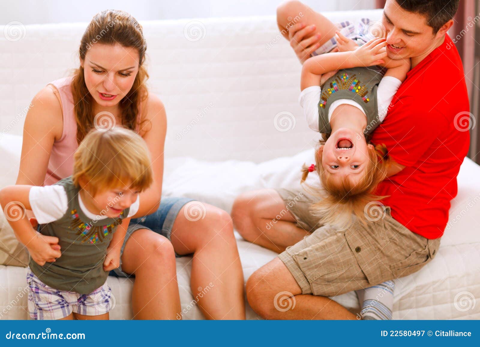 Parents Having Fun with Daughters on Couch Stock Image - Image of ...