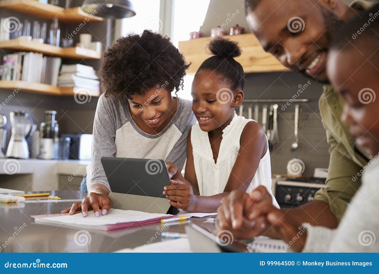Parents Helping Children with Homework in Kitchen Stock Photo - Image ...