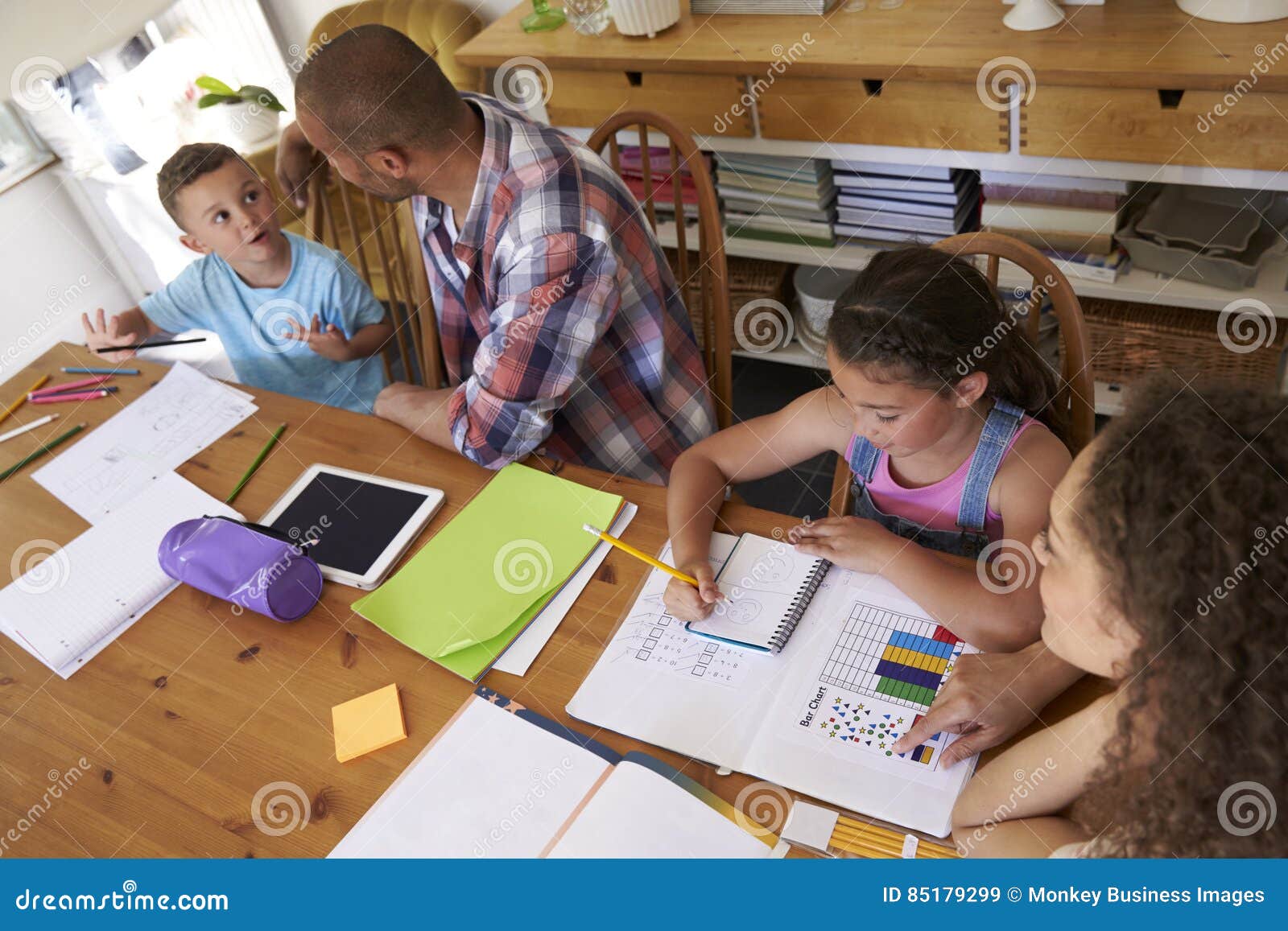 Parents Helping Children with Homework at Table Stock Image - Image of ...