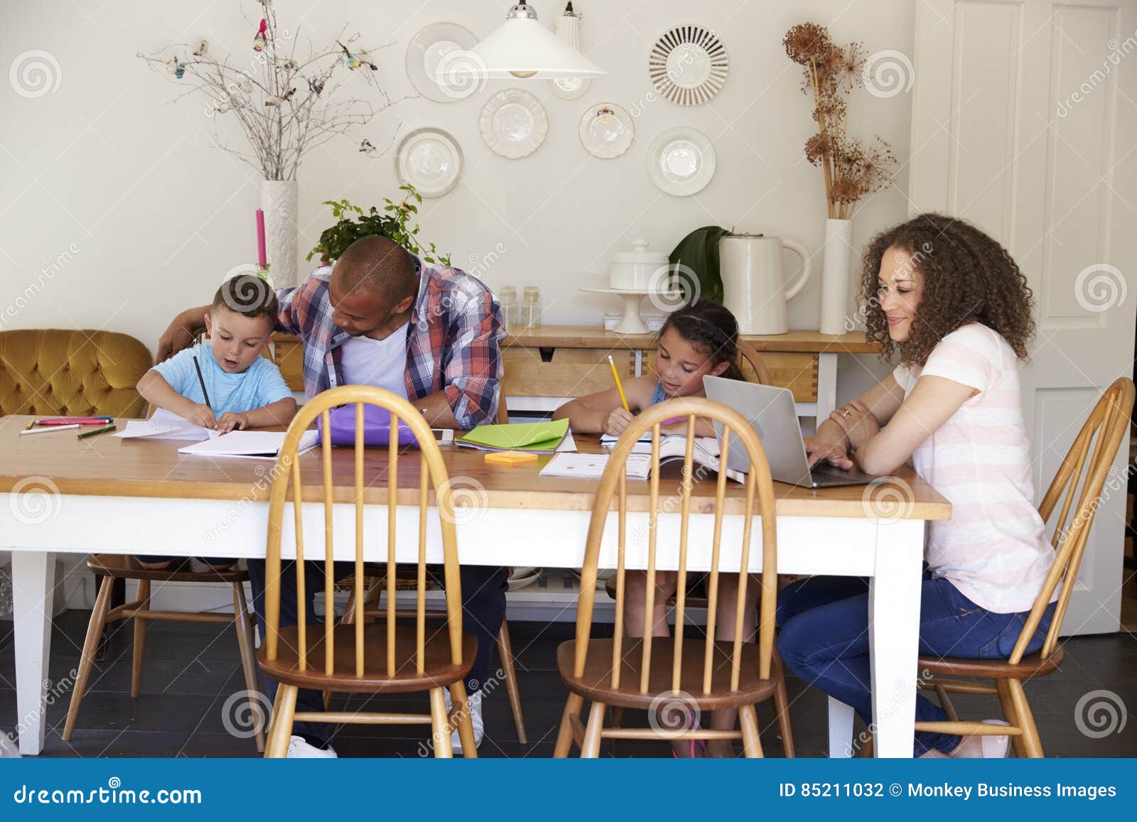 Parents Helping Children with Homework at Table Stock Photo - Image of ...