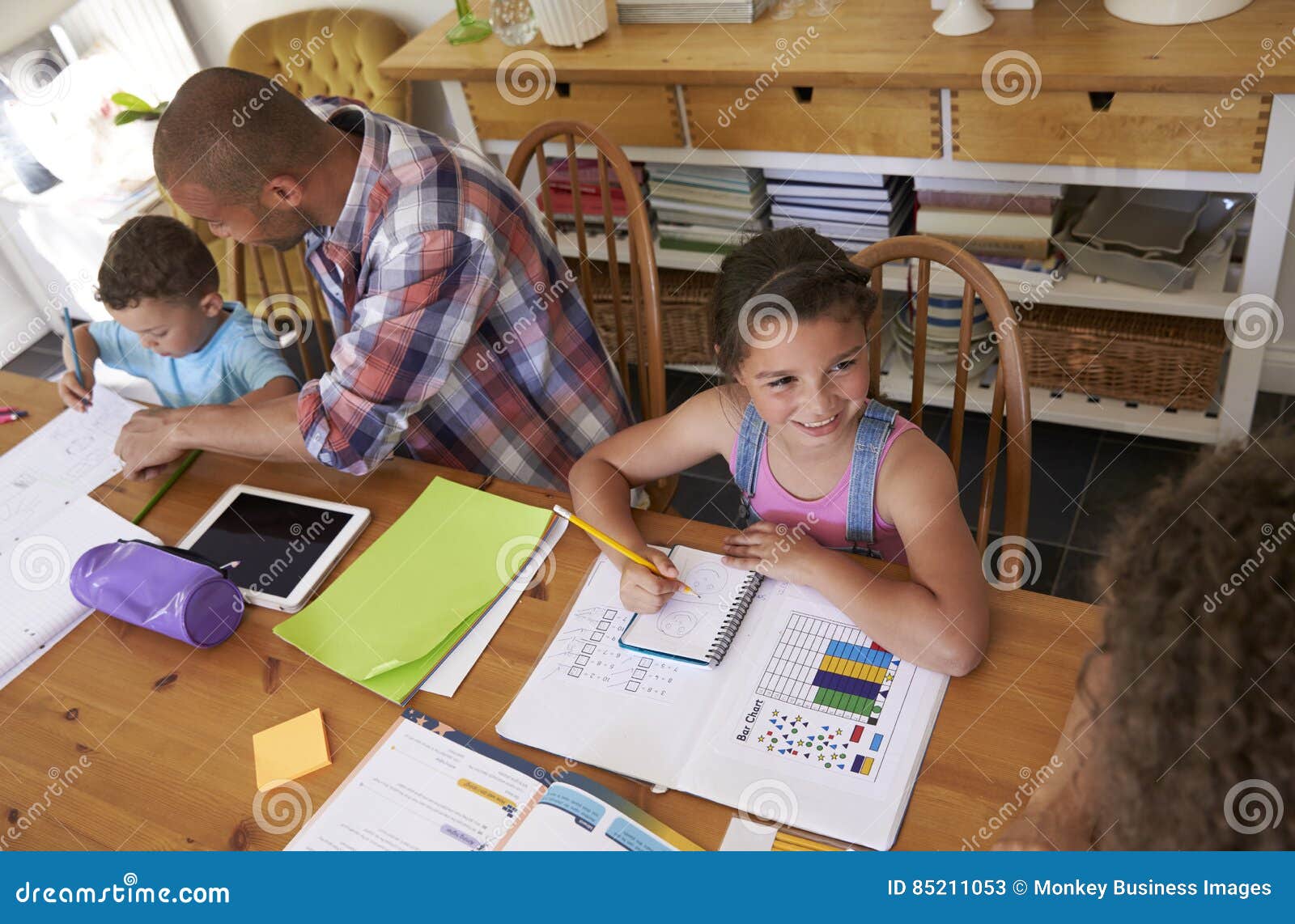 Parents Helping Children with Homework at Table Stock Image - Image of ...