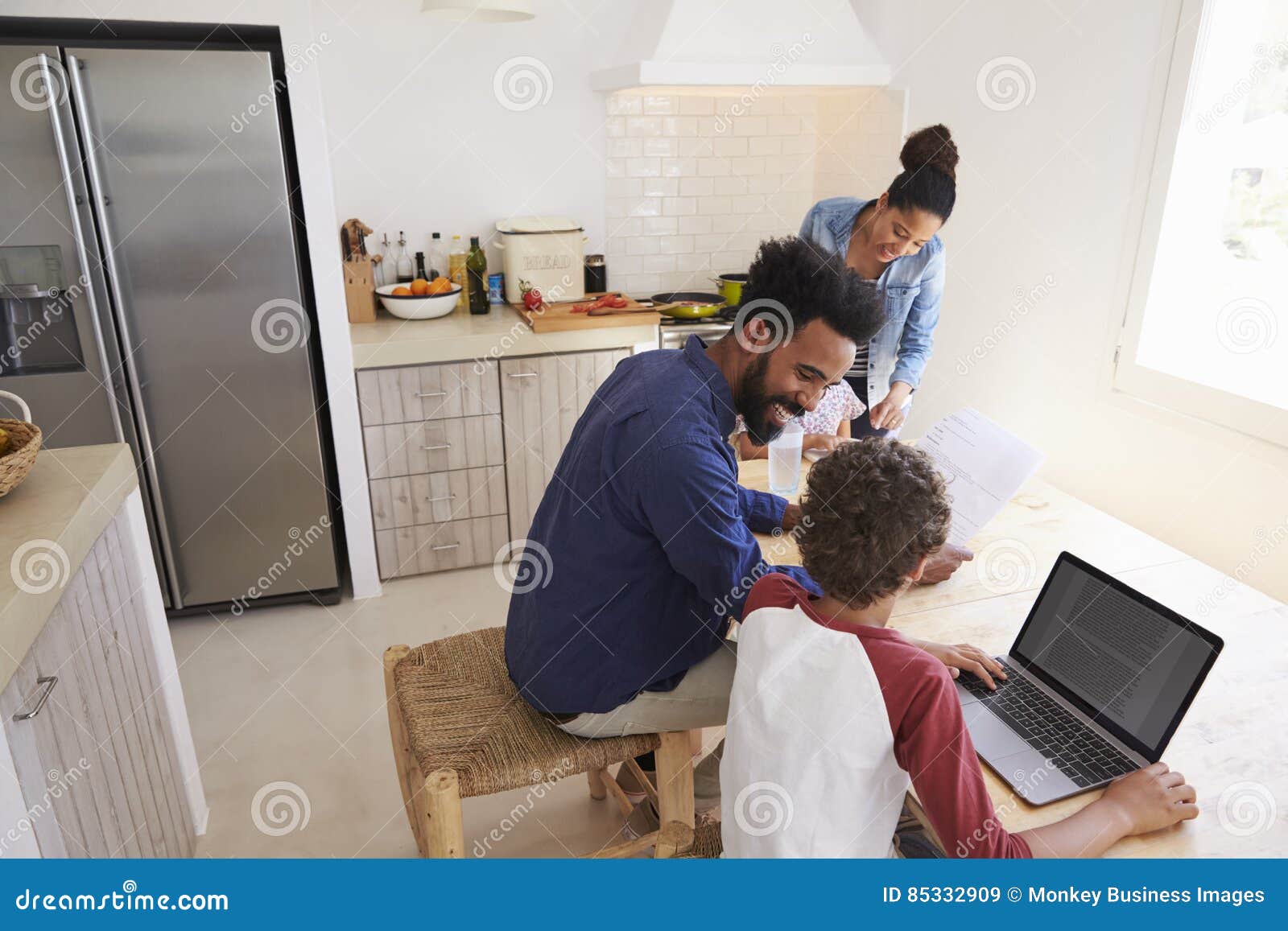 Parents Helping Kids with Homework in Kitchen, Elevated View Stock ...