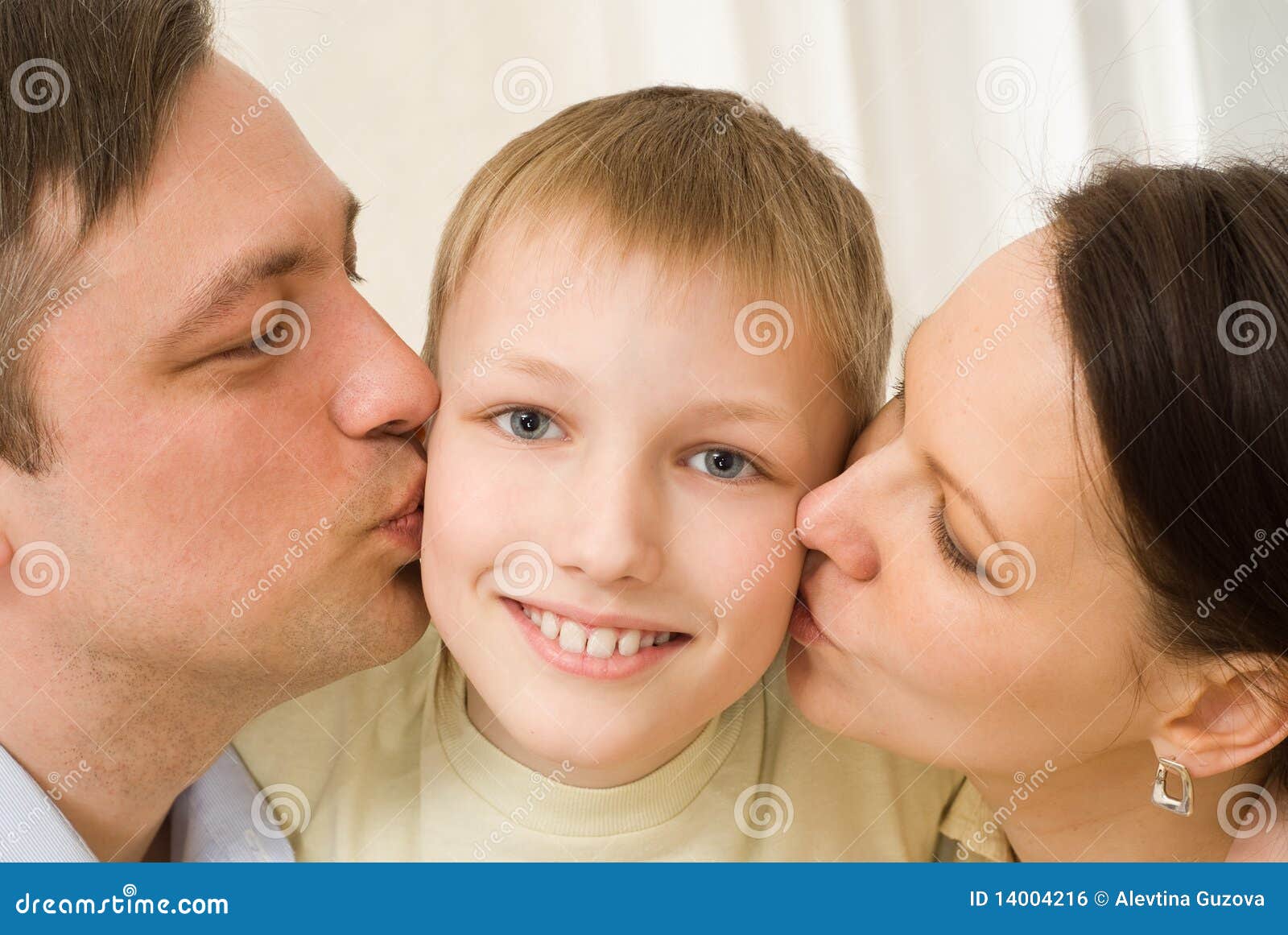 Parents kissing her child stock photo. Image of life - 14004216