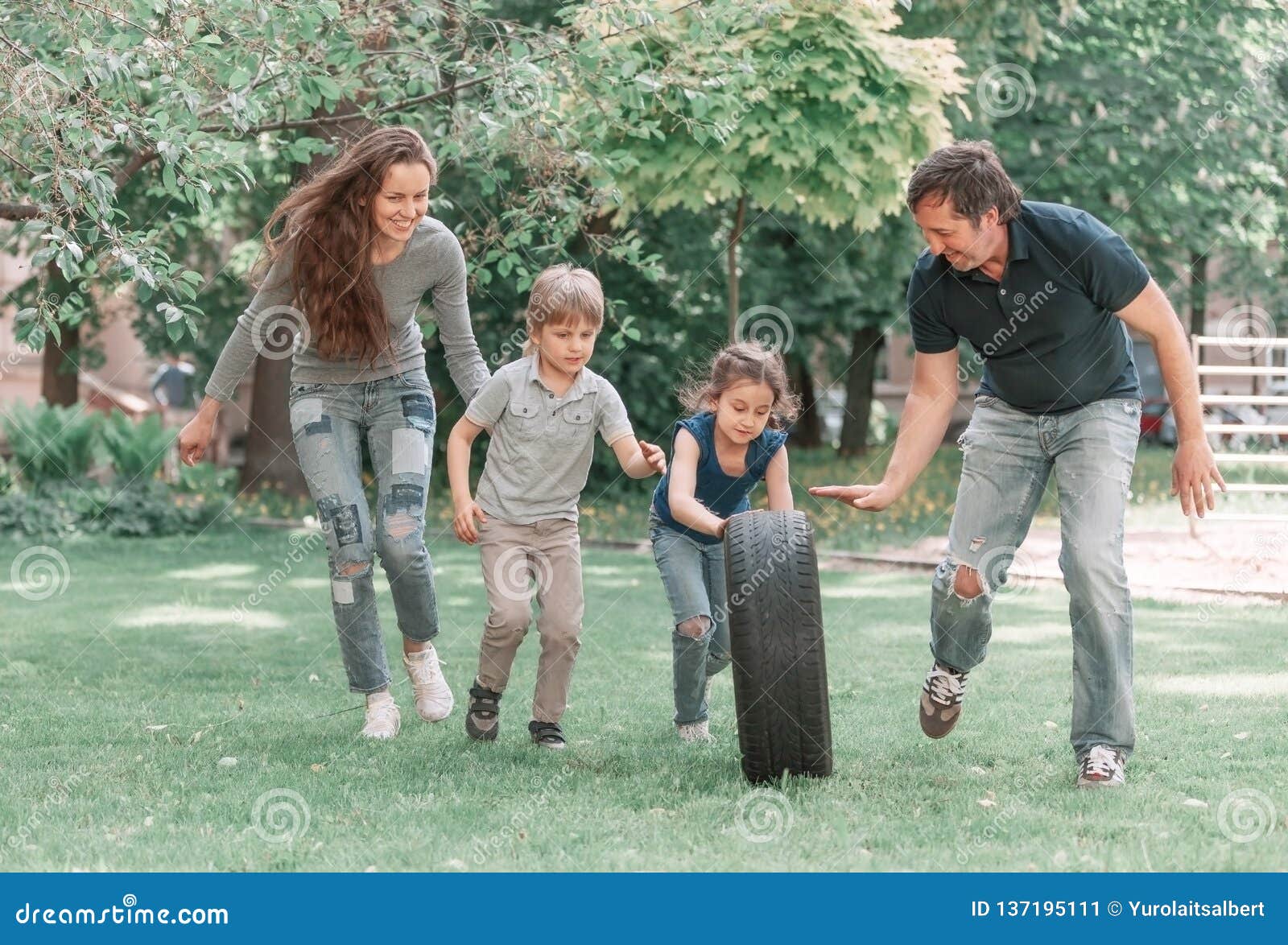 Parents Play with Their Children on the Playground Near the House Stock ... Parents Play with Their Children on the Playground Near the House Stock ...