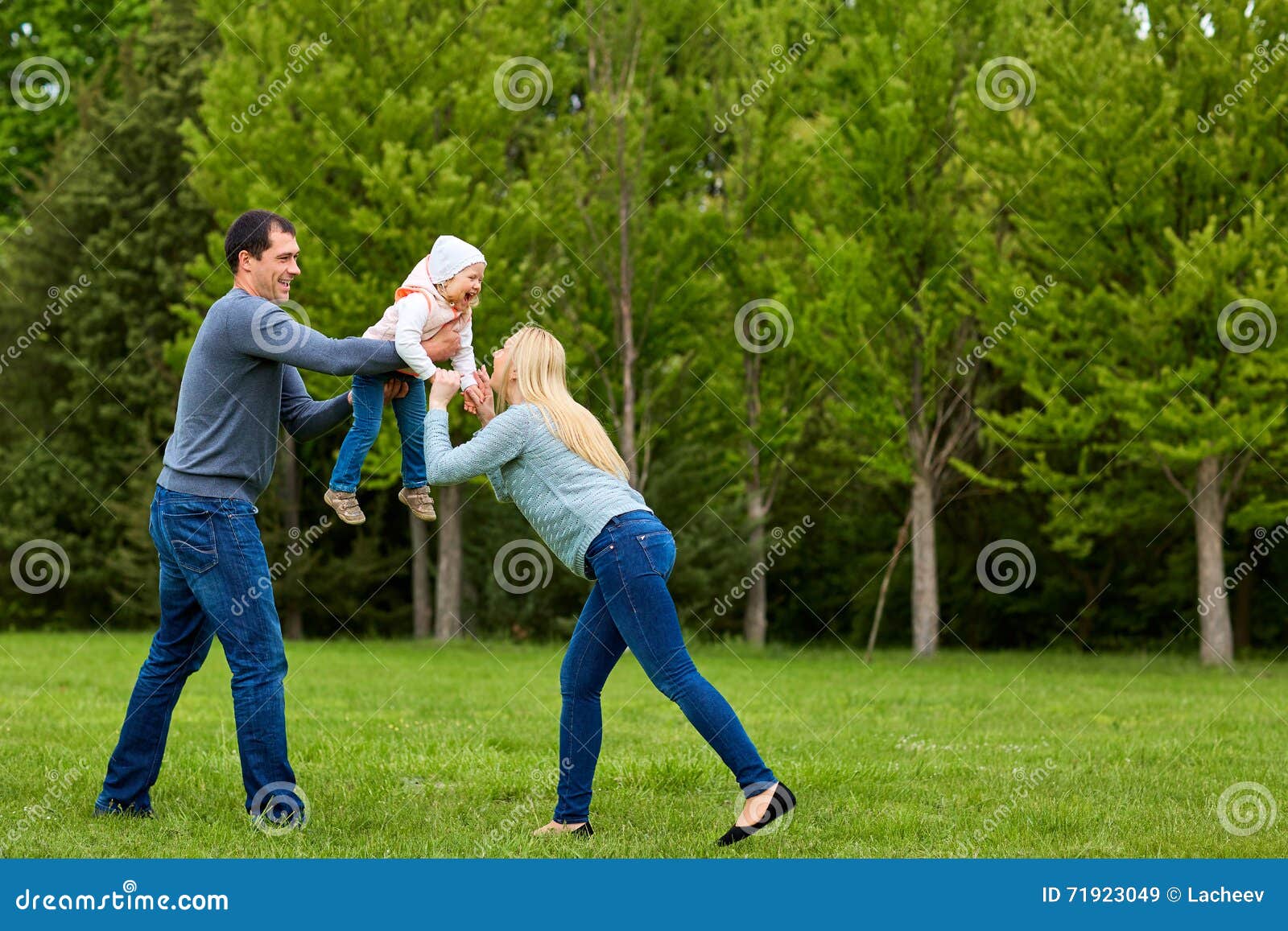Parents Playing Exciting with Child in the Park.Happy Family. Stock ... Parents Playing Exciting with Child in the Park.Happy Family. Stock ...