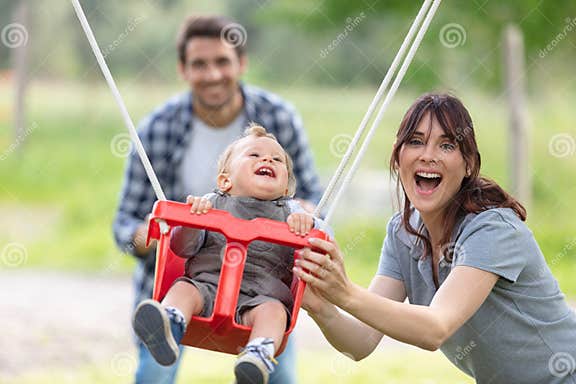 Parents Playing with Their Child Stock Image - Image of green ...