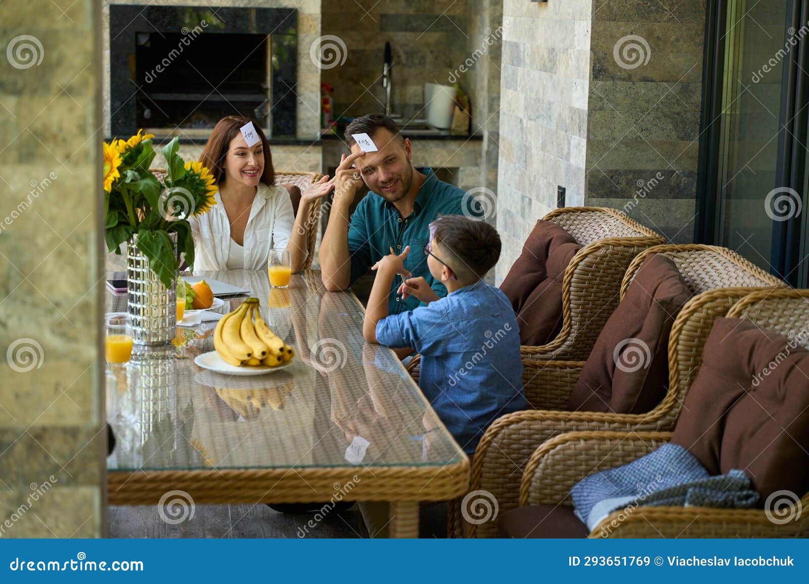 Parents Sit at the Table with Stickers on Their Foreheads Stock Image ...