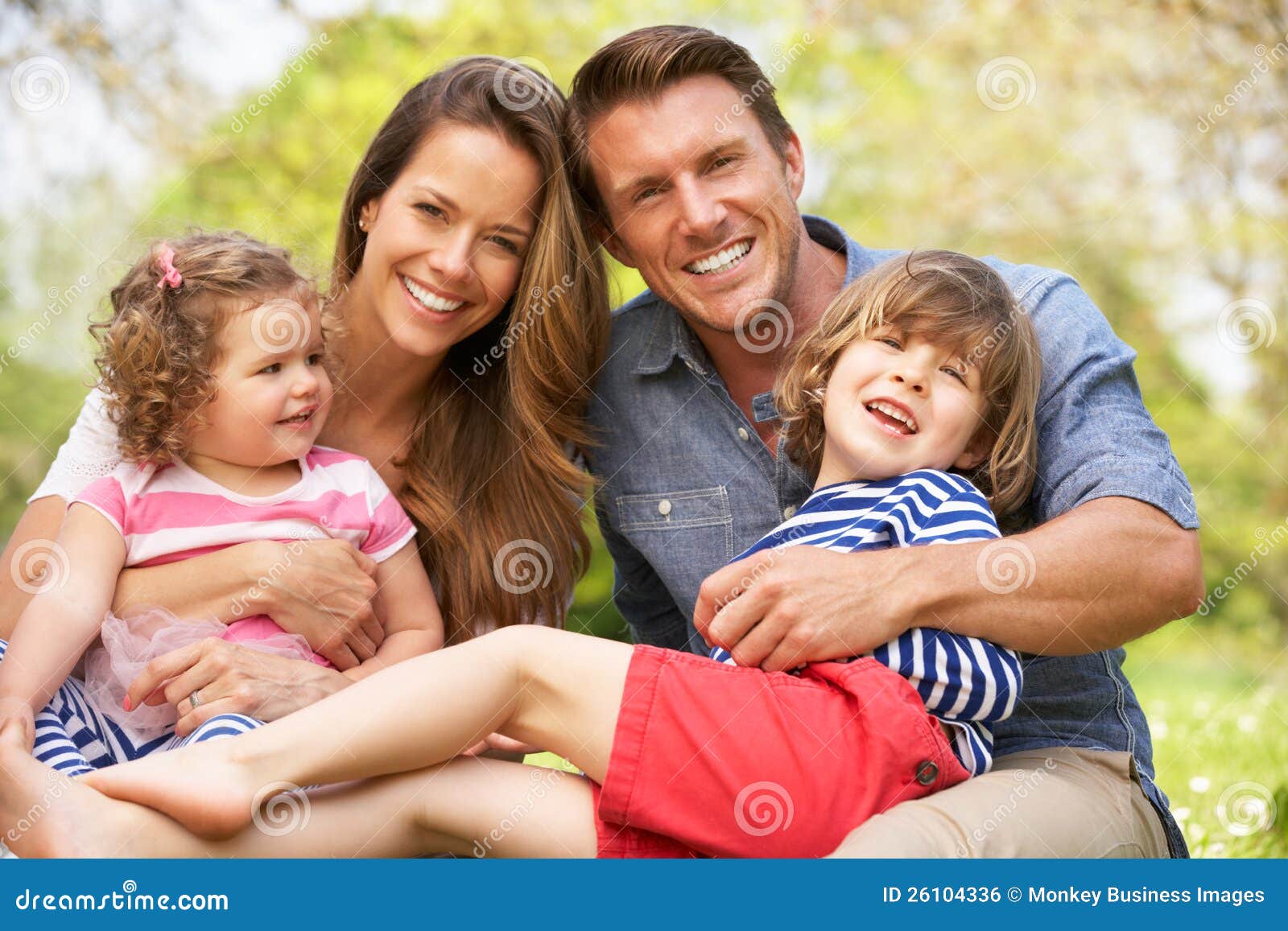 Parents Sitting with Children in Field Stock Photo - Image of happy ...