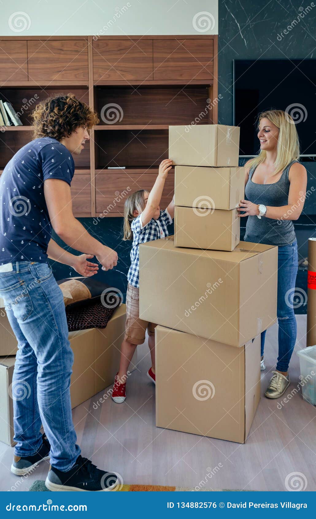 Parents with Child Helping To Make Move Stock Photo - Image of move ...