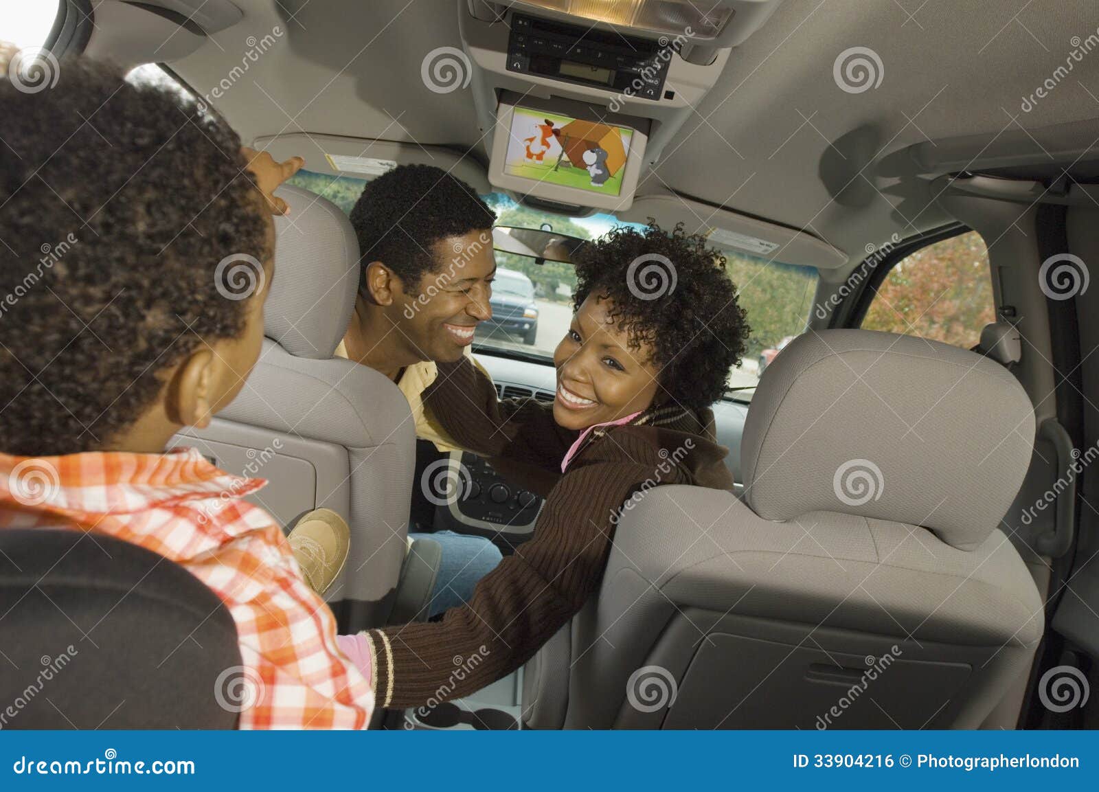 Parents with Son Sitting in Car Stock Photo - Image of loving ...