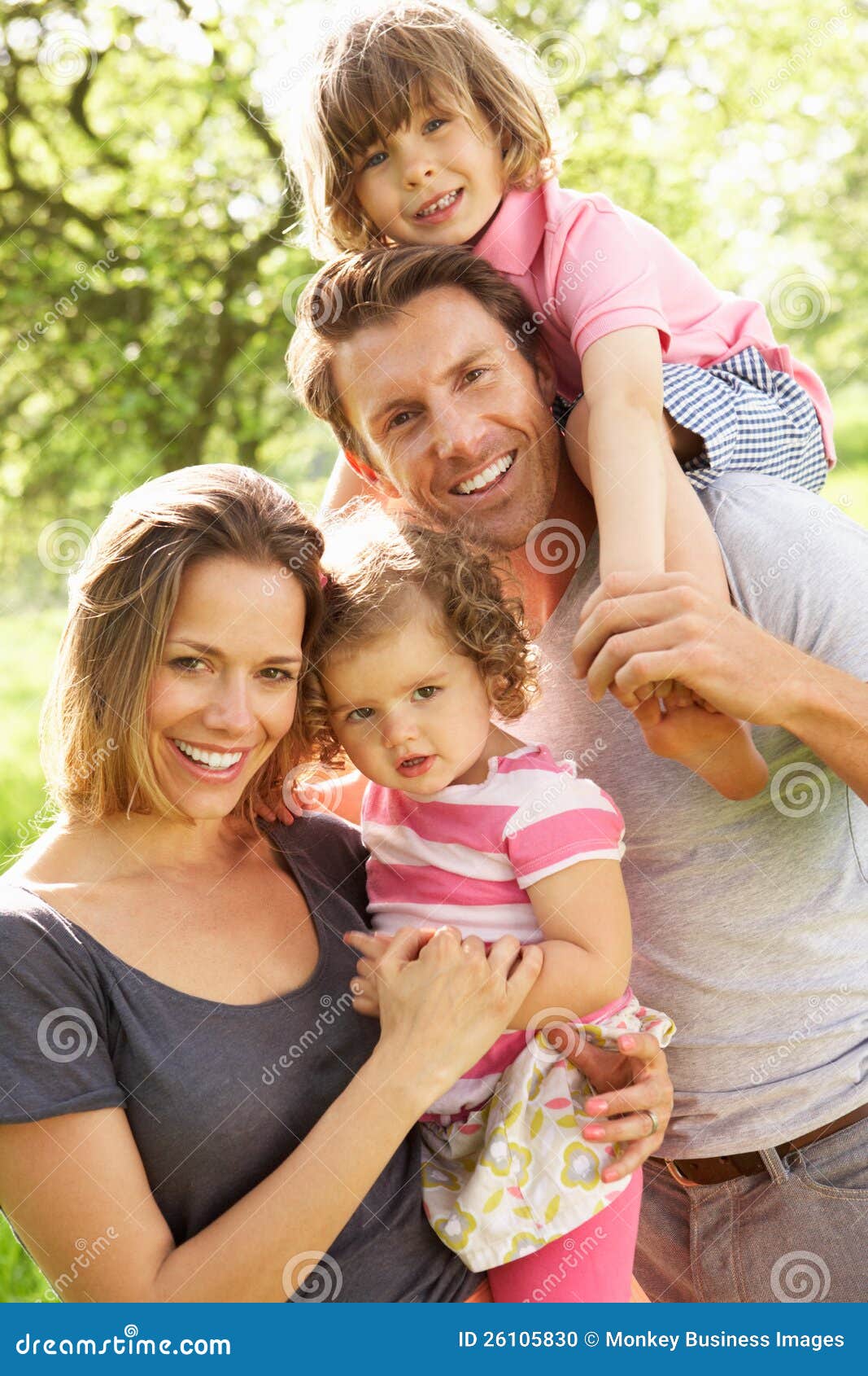 Parents Standing with Children in Field Stock Photo - Image of four ...