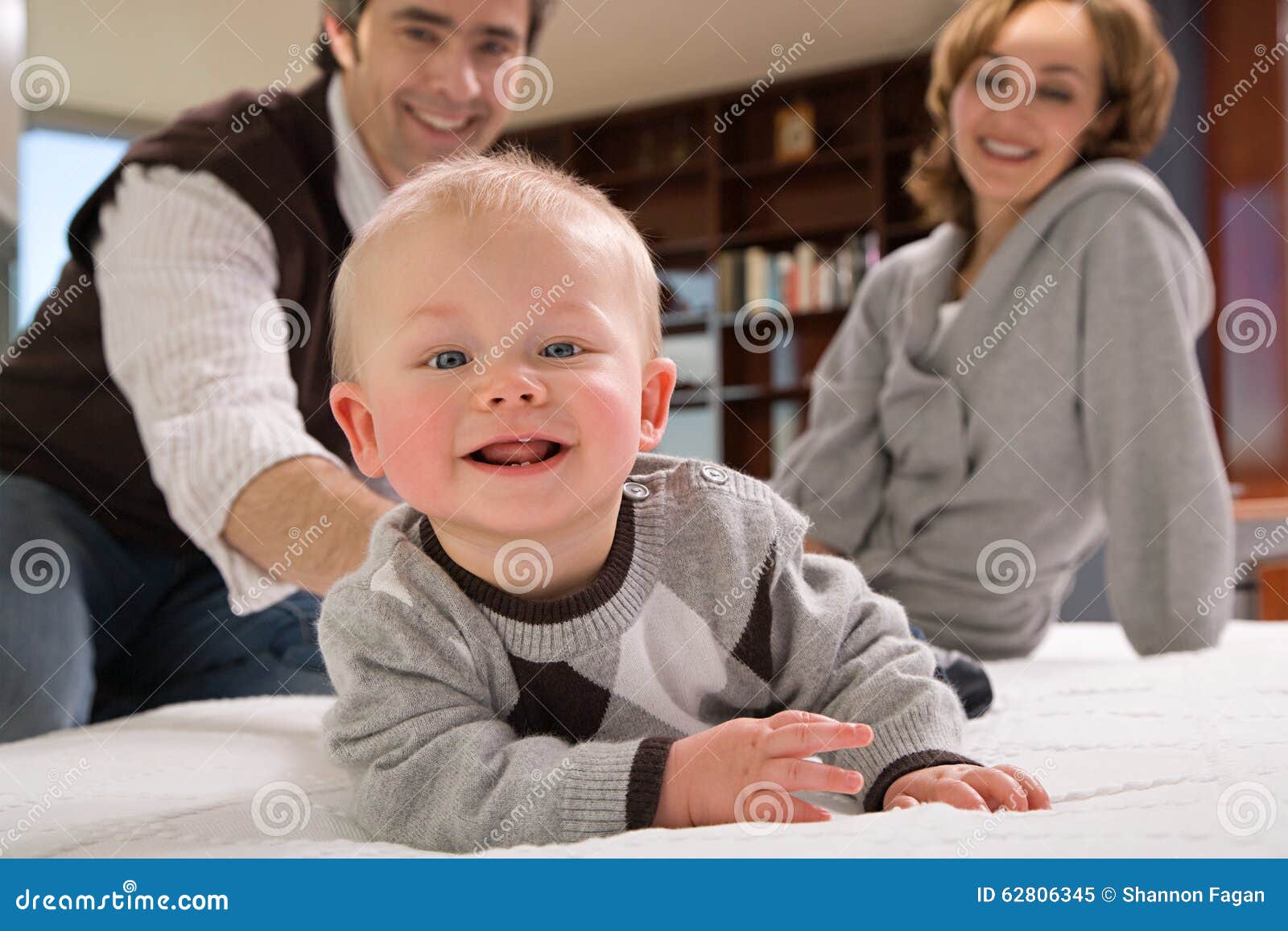 Parents and their baby stock image. Image of indoors - 62806345