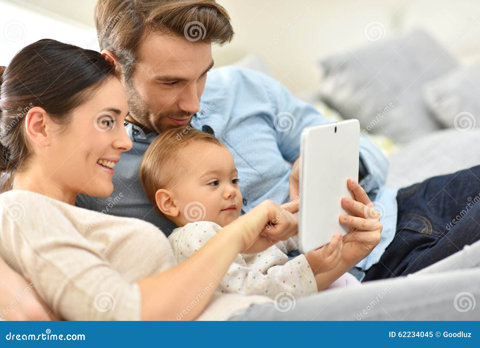 Parents with Their Baby Playing on Tablet Stock Image - Image of people ...