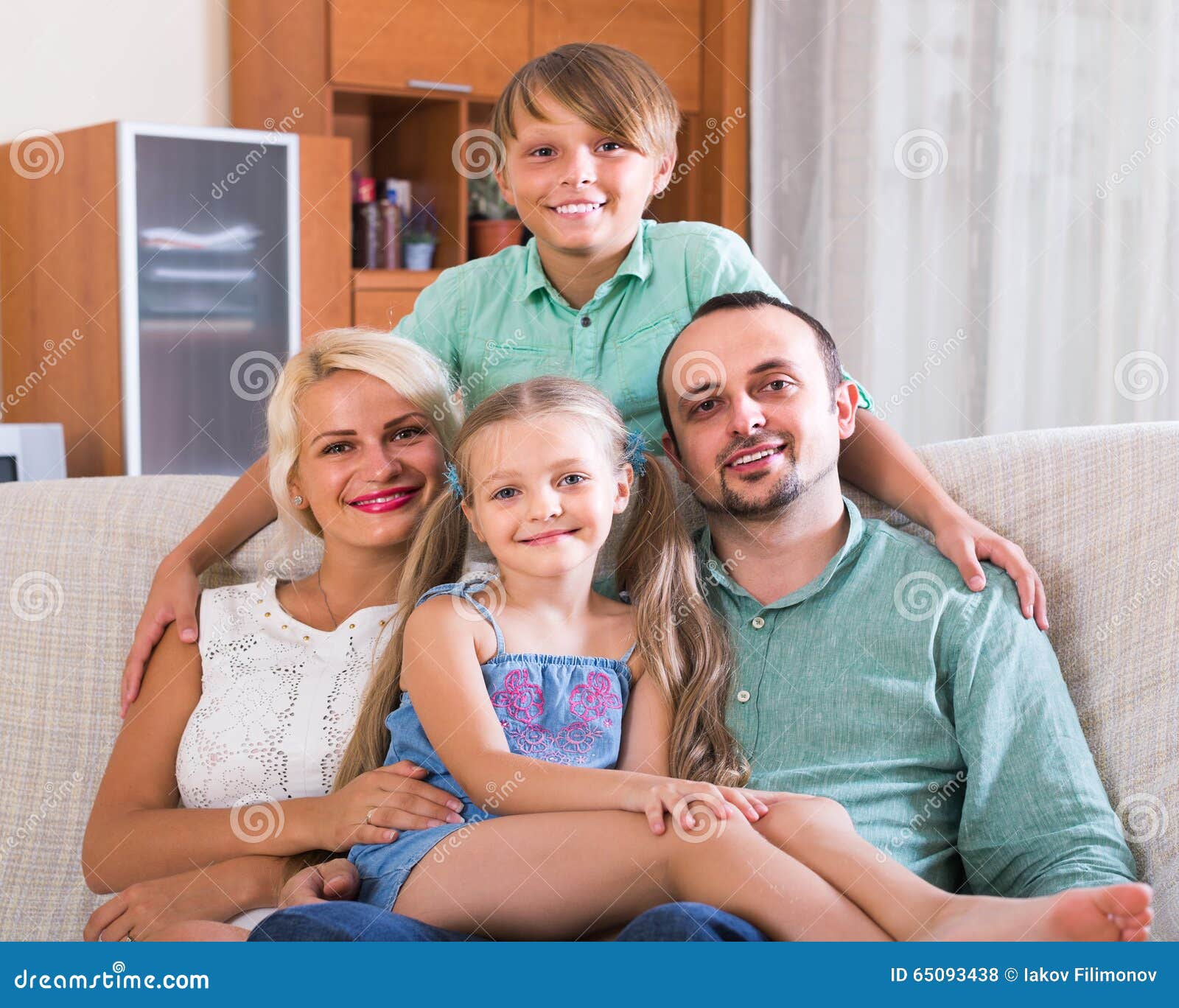 Parents with Two Children Posing in Home Interior Stock Photo - Image ...