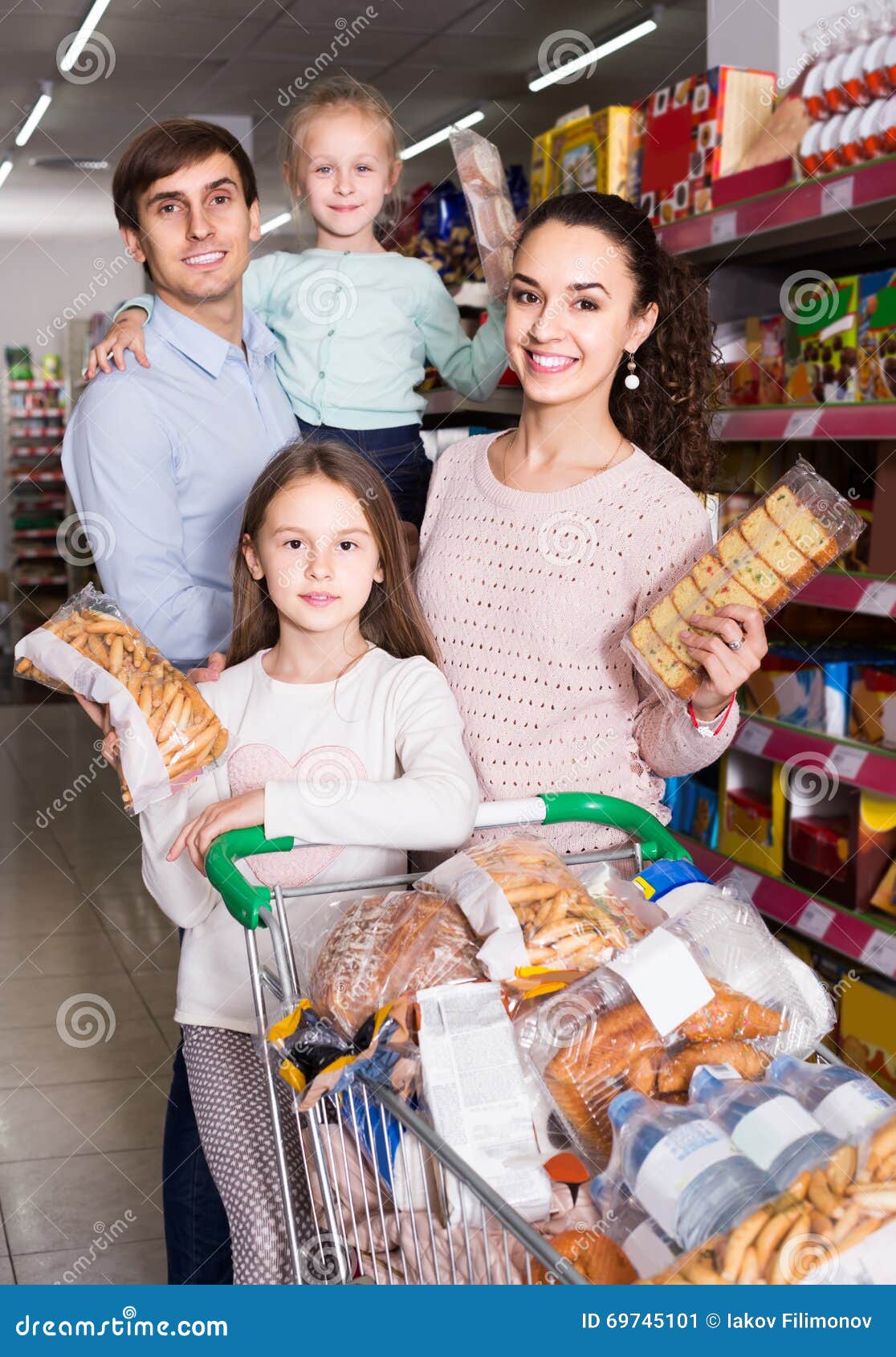 Parents with Two Kids Choosing Biscuits in Store Stock Image - Image of ...