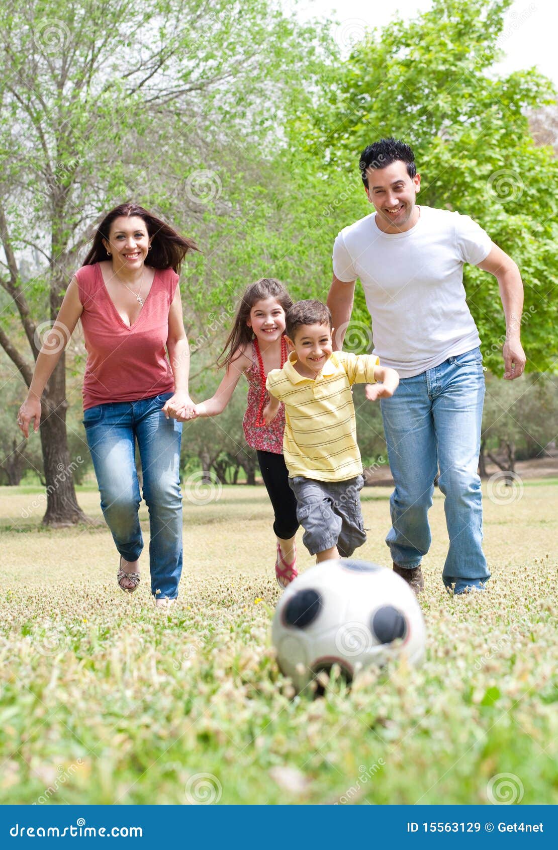 Parents And Two Young Children Playing Soccer Stock Image - Image: 15563129