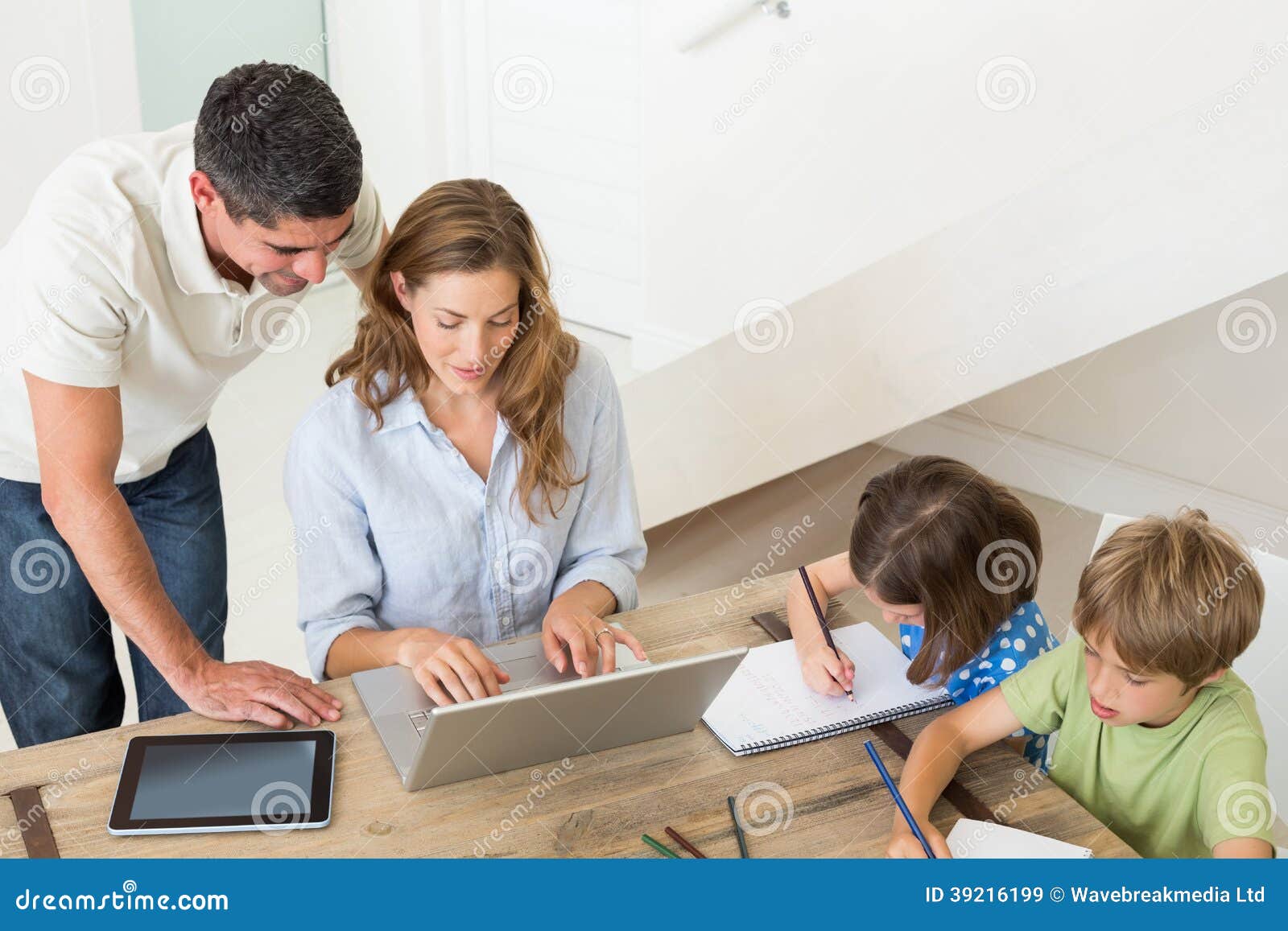 Parents Using Laptop while Children Coloring at Home Stock Image ...