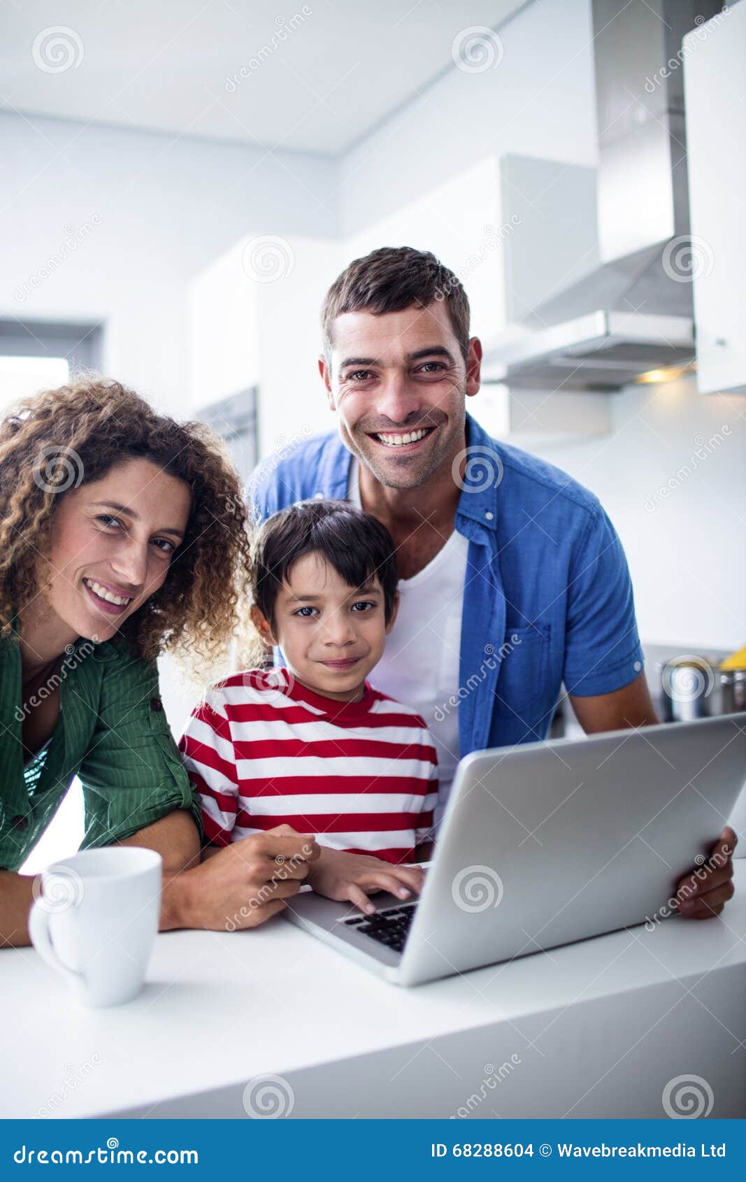 Parents Using Laptop with Son in Kitchen Stock Photo - Image of adult ...