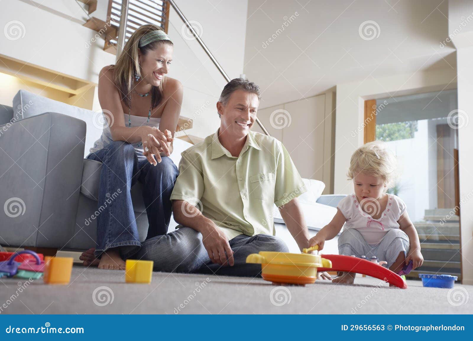 Parents Watching Son Playing with Toy Stock Image - Image of male ...
