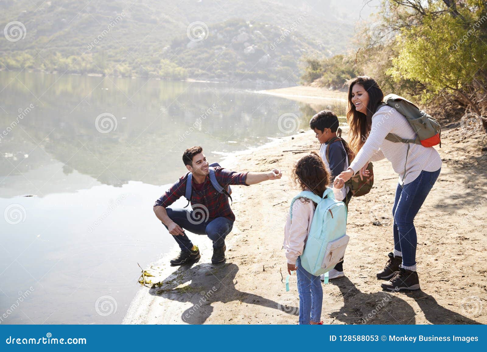 Parents with Young Children Exploring beside a Mountain Lake Stock ...