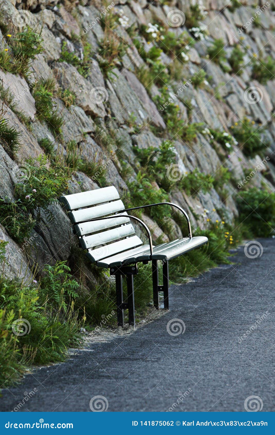 A Lonely Park Bench Placed by the Wall. Stock Photo - Image of ...